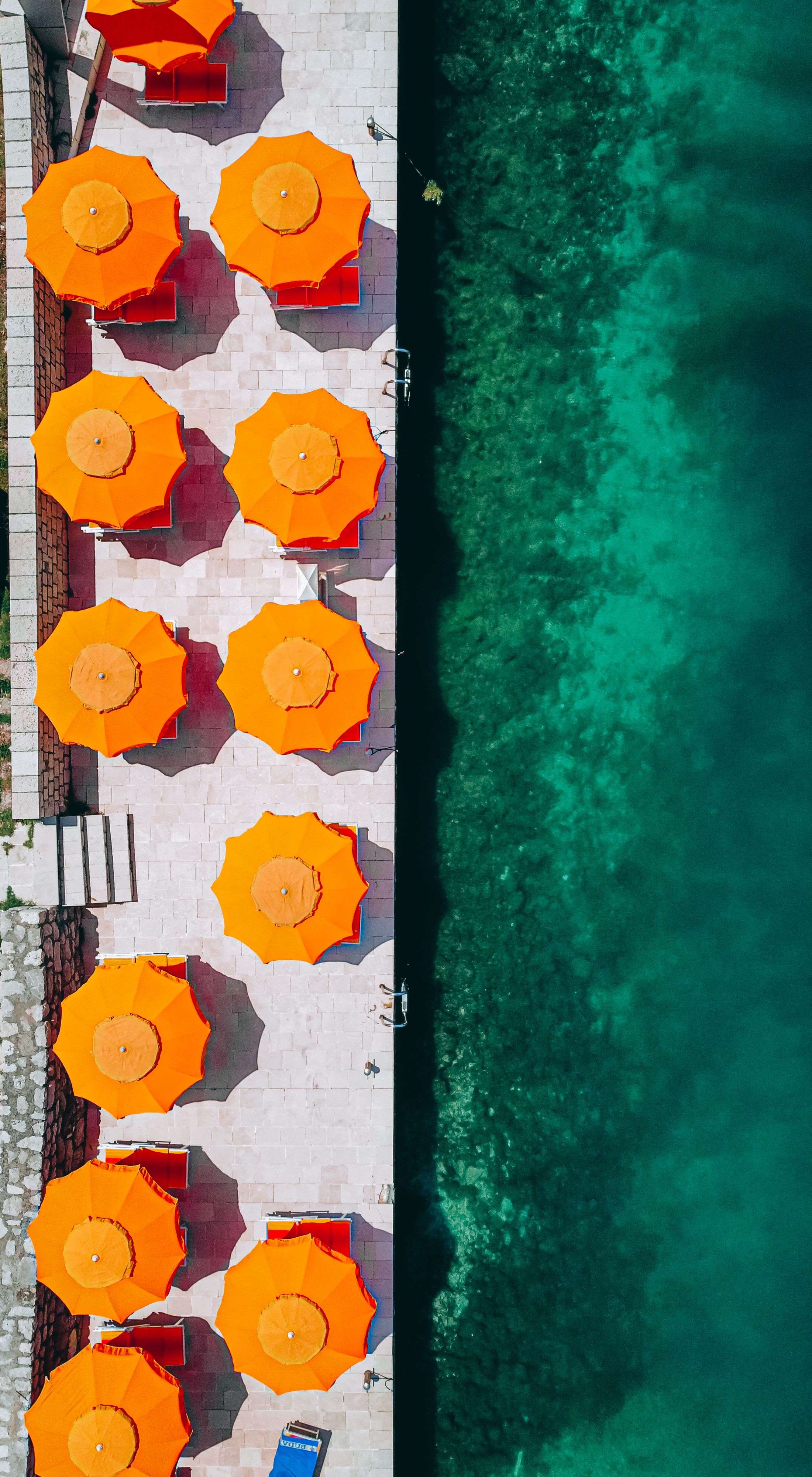 Top View of Orange Umbrellas on the Poolside · Free Stock Photo