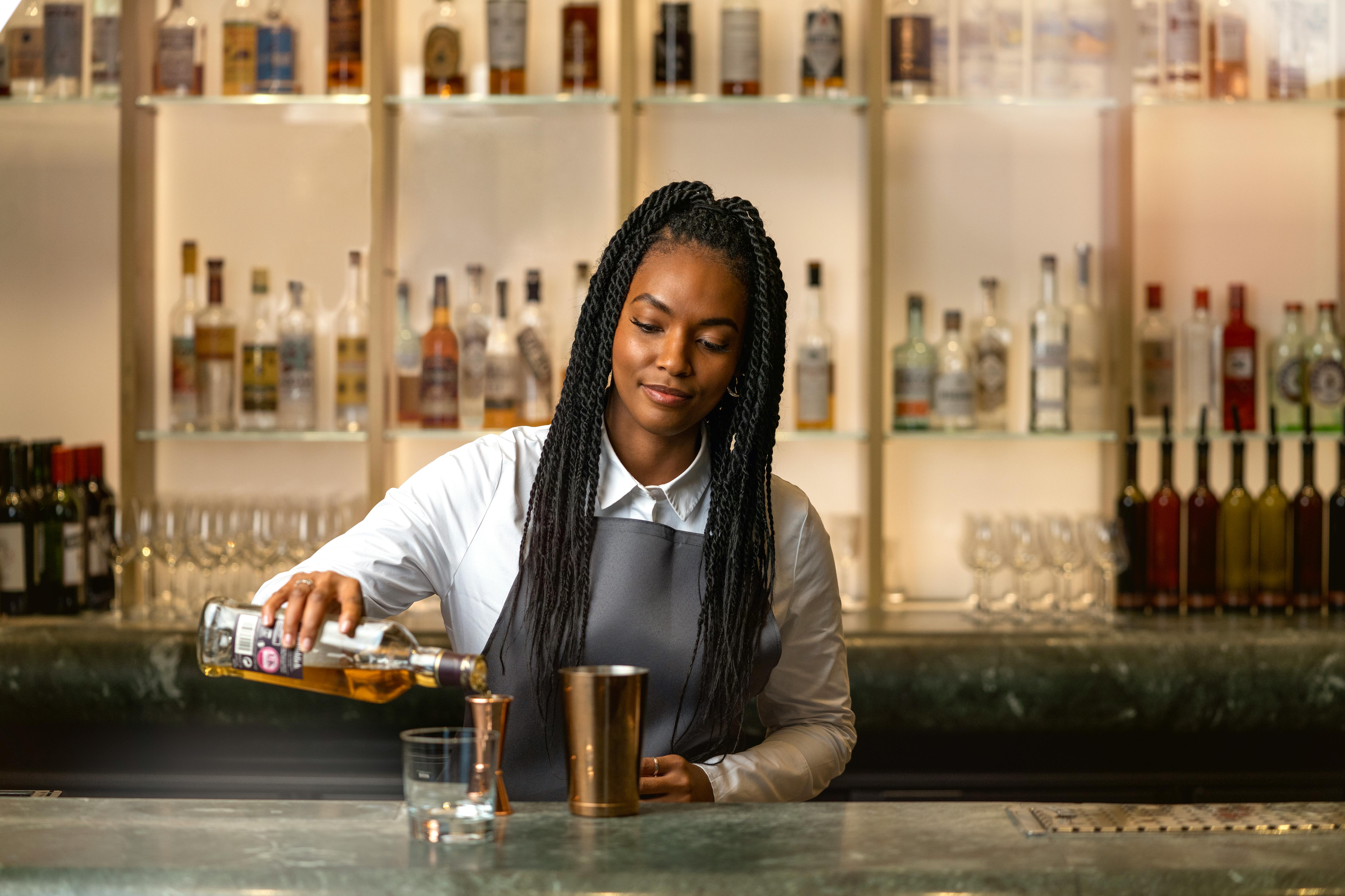 Barmaid Pouring Alcohol · Free Stock Photo