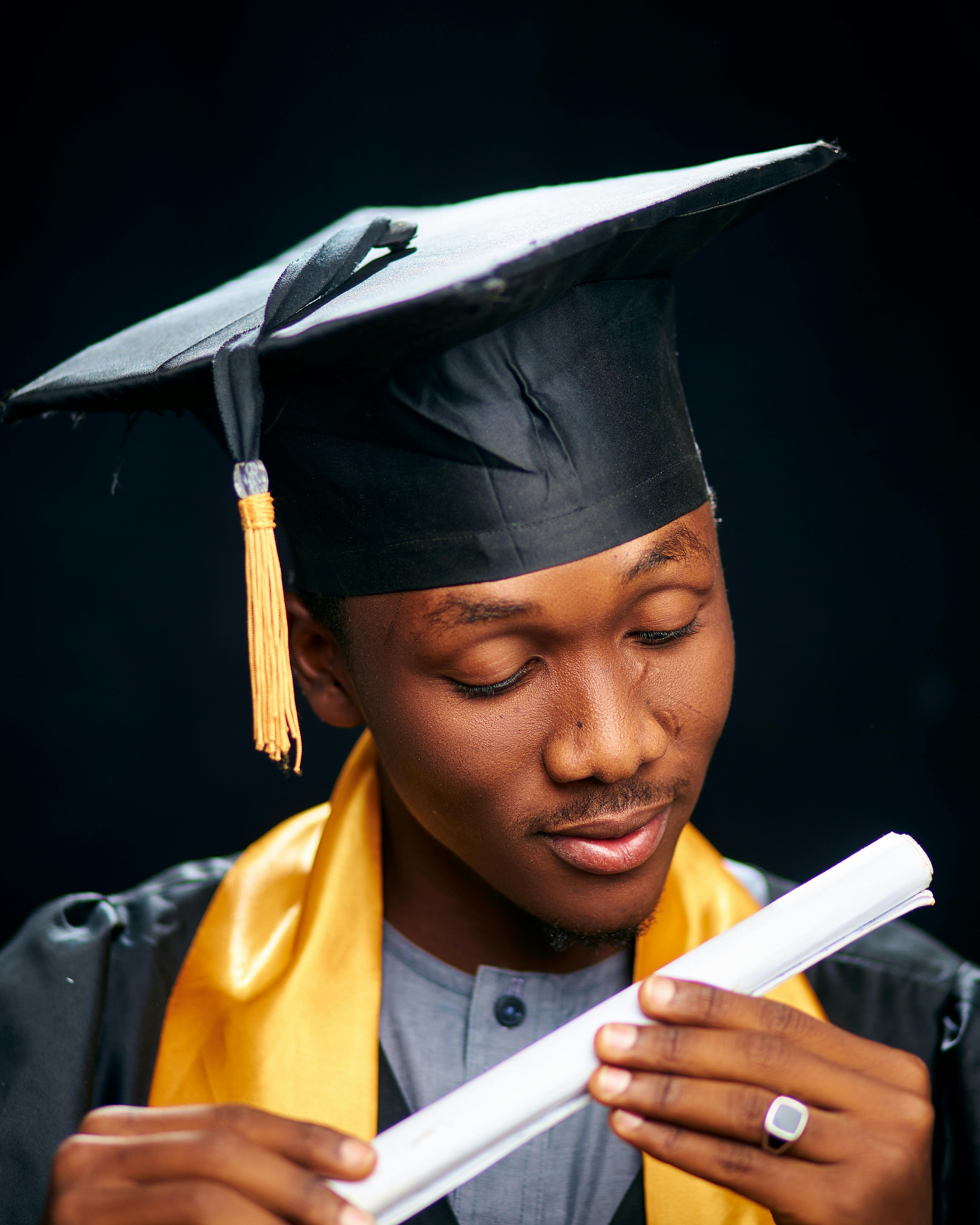 A Graduate Holding His Diploma · Free Stock Photo