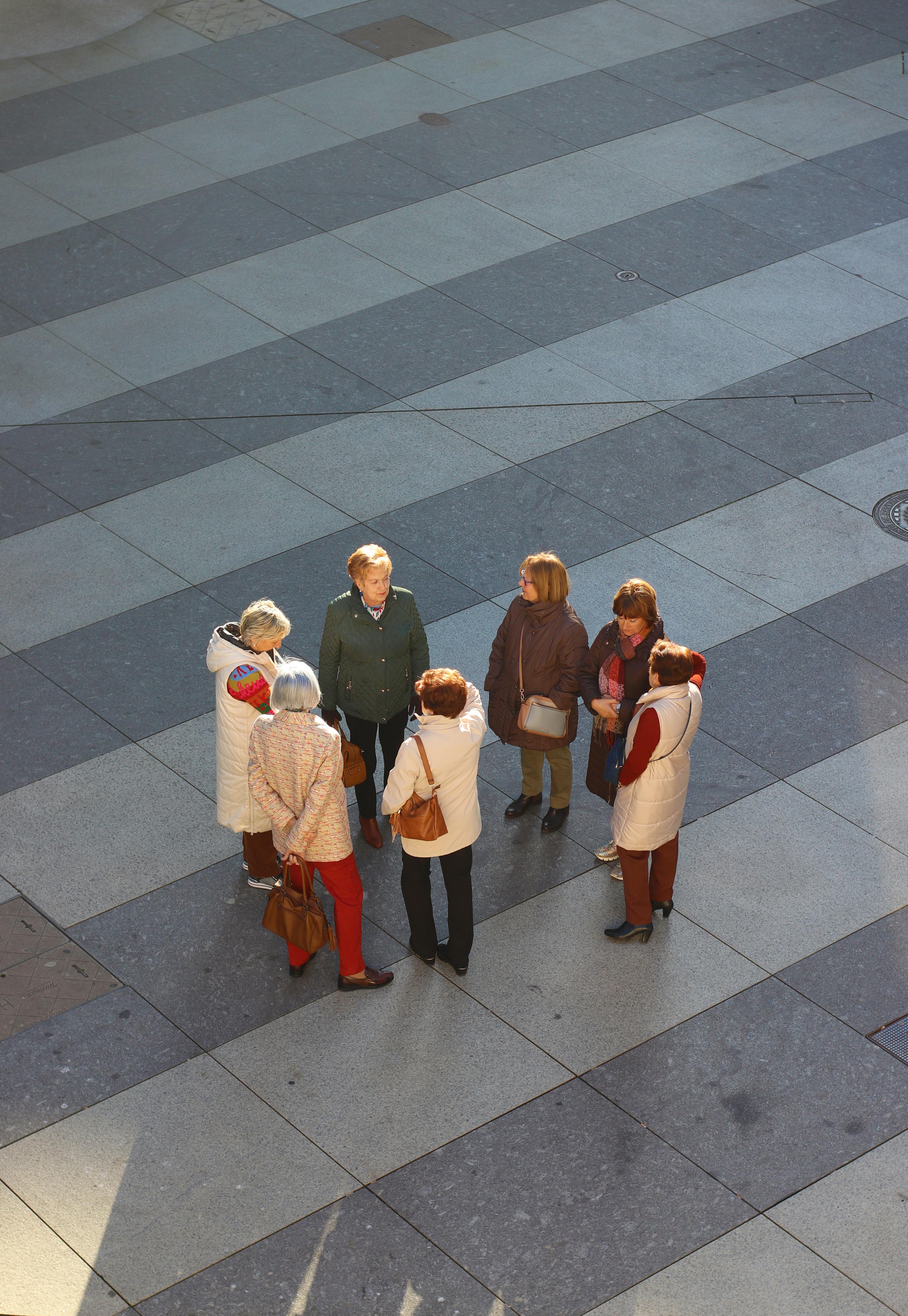 People in Jackets Standing on Pavement in Town · Free Stock Photo