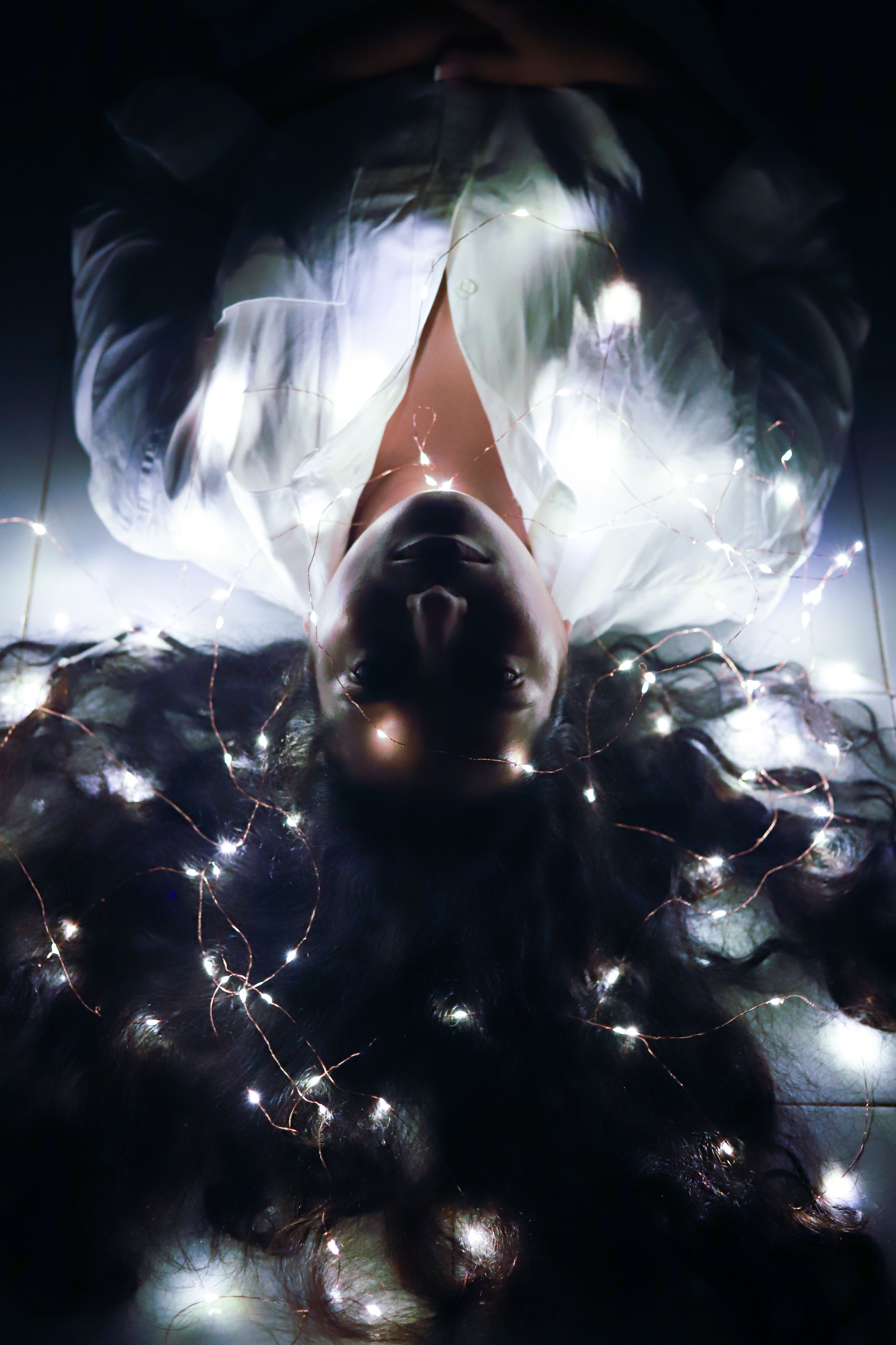 Lamps Lights on Woman Lying Down in White Shirt · Free Stock Photo
