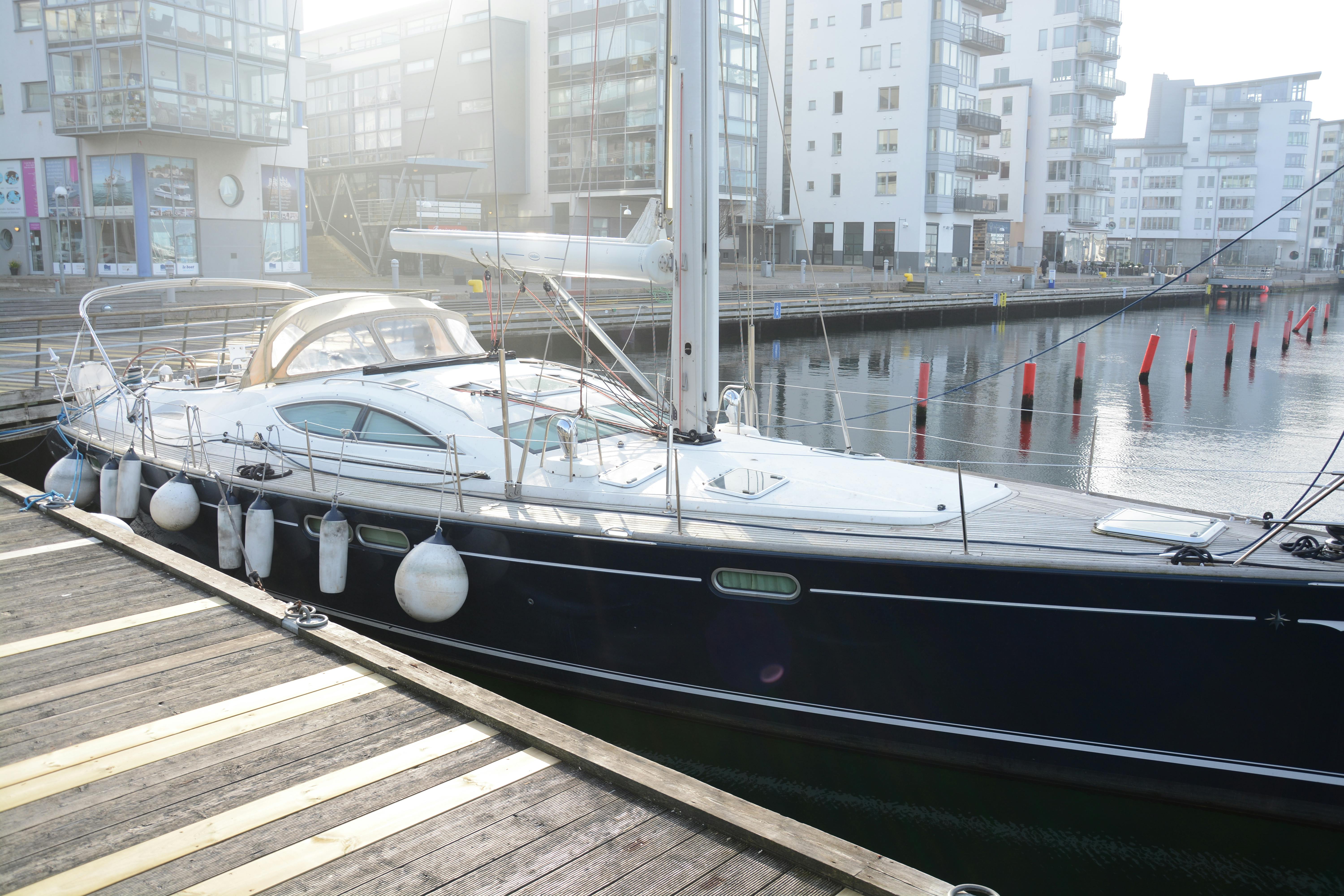 Motor boat sailing on sea near city port · Free Stock Photo