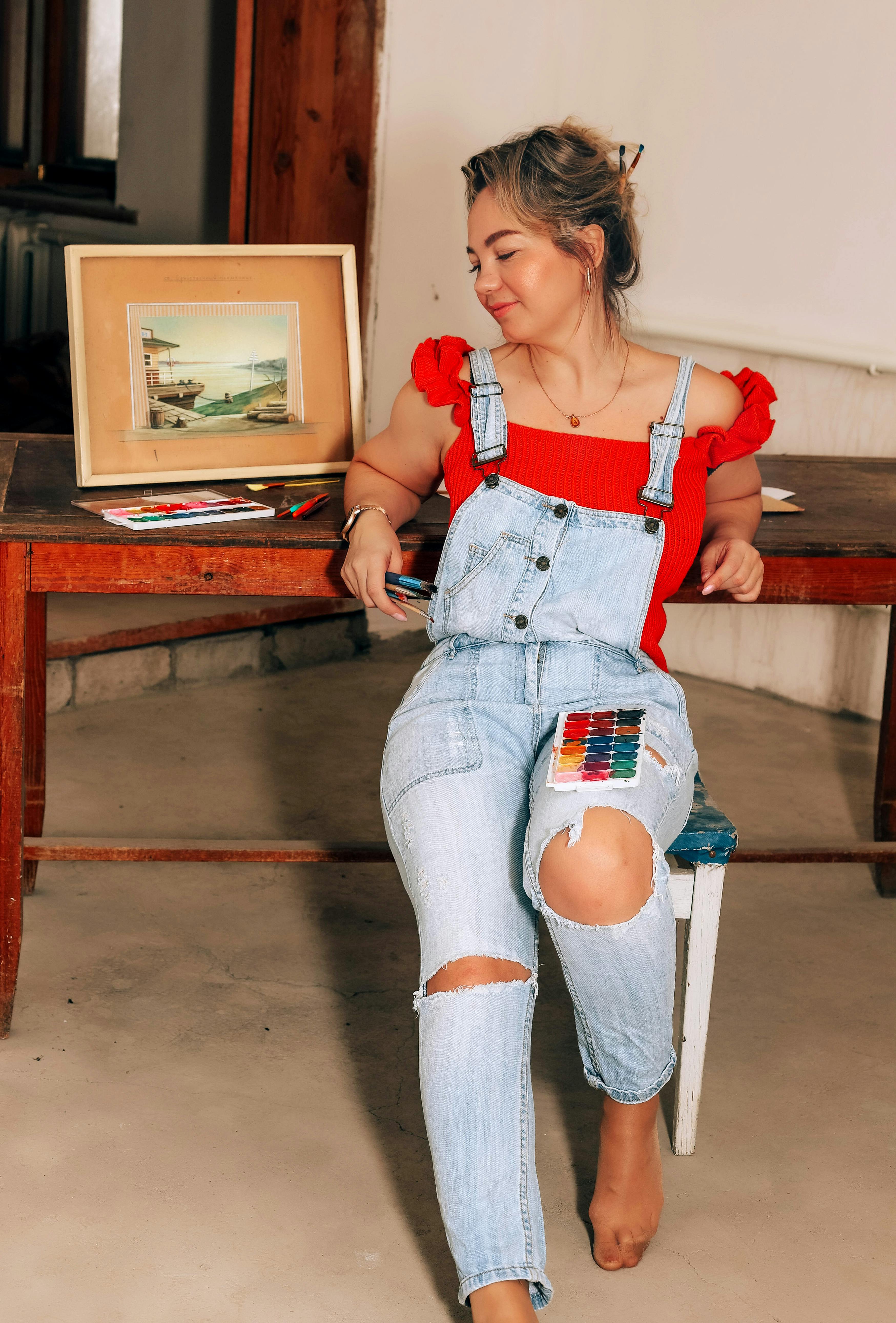 Woman Posing by Painting on Table · Free Stock Photo