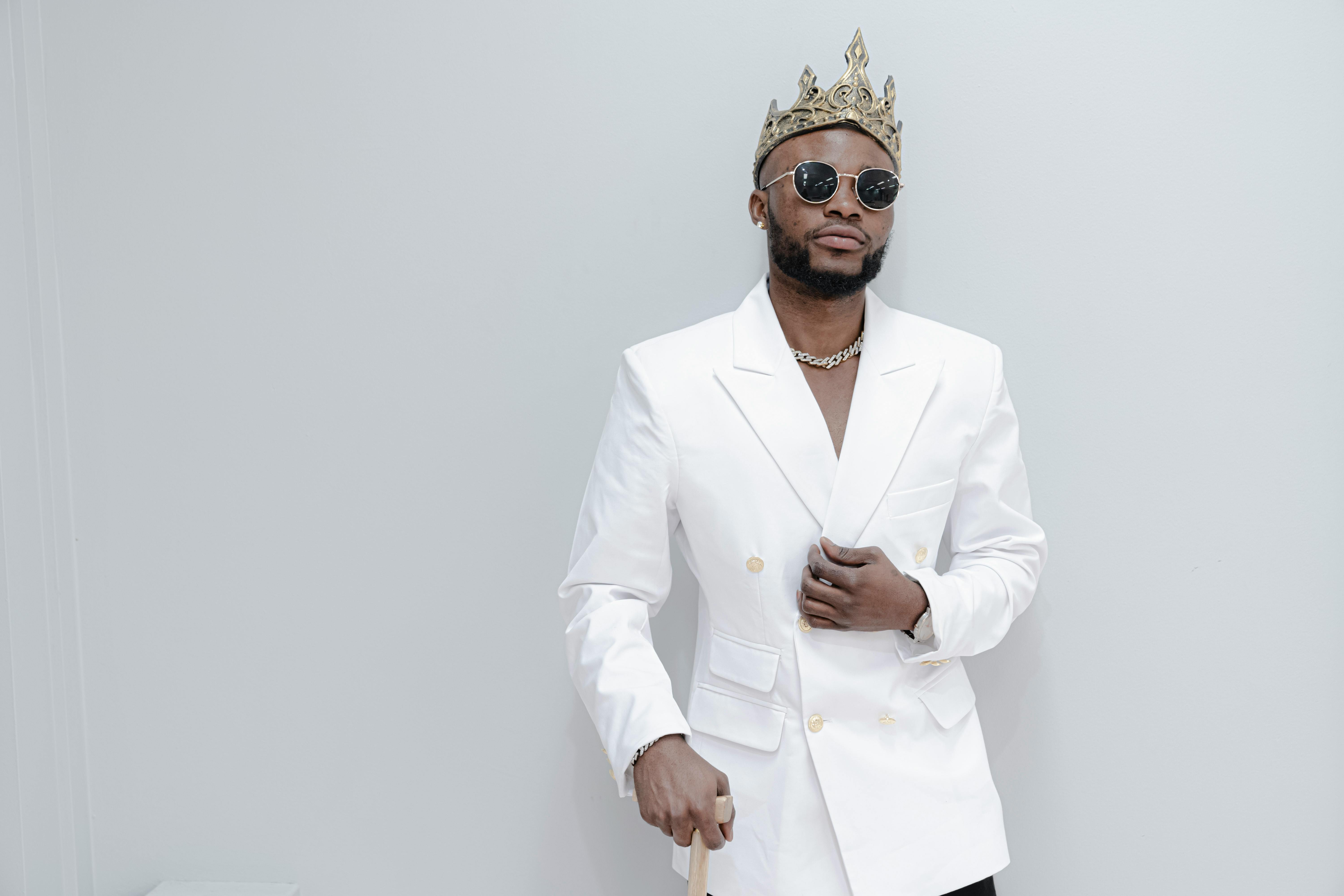 Man Posing in White Suit, Crown and Sunglasses · Free Stock Photo