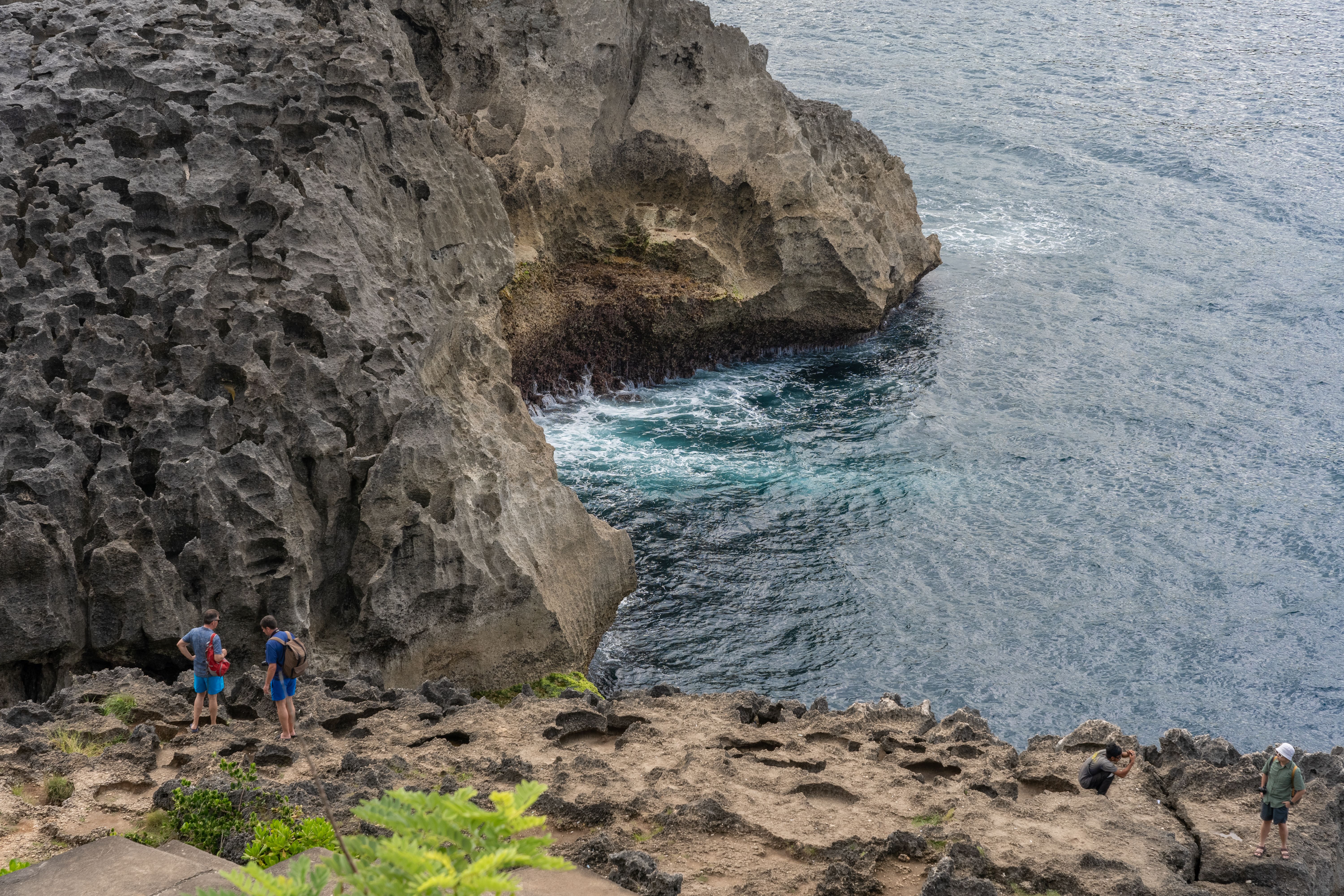 People Hiking on Rocky Cliffs on the Shore · Free Stock Photo