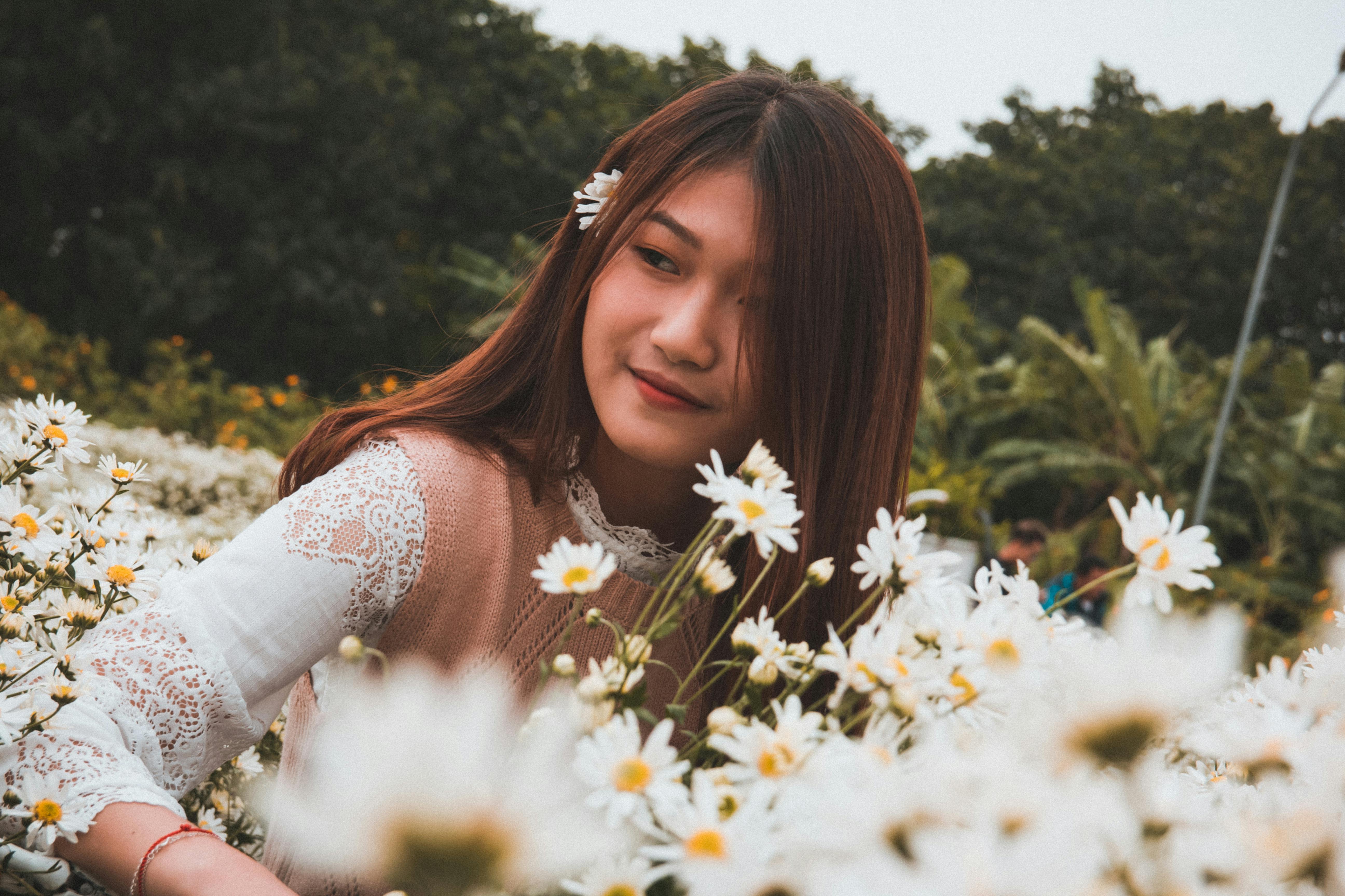 Woman Surrounded by Flowers · Free Stock Photo