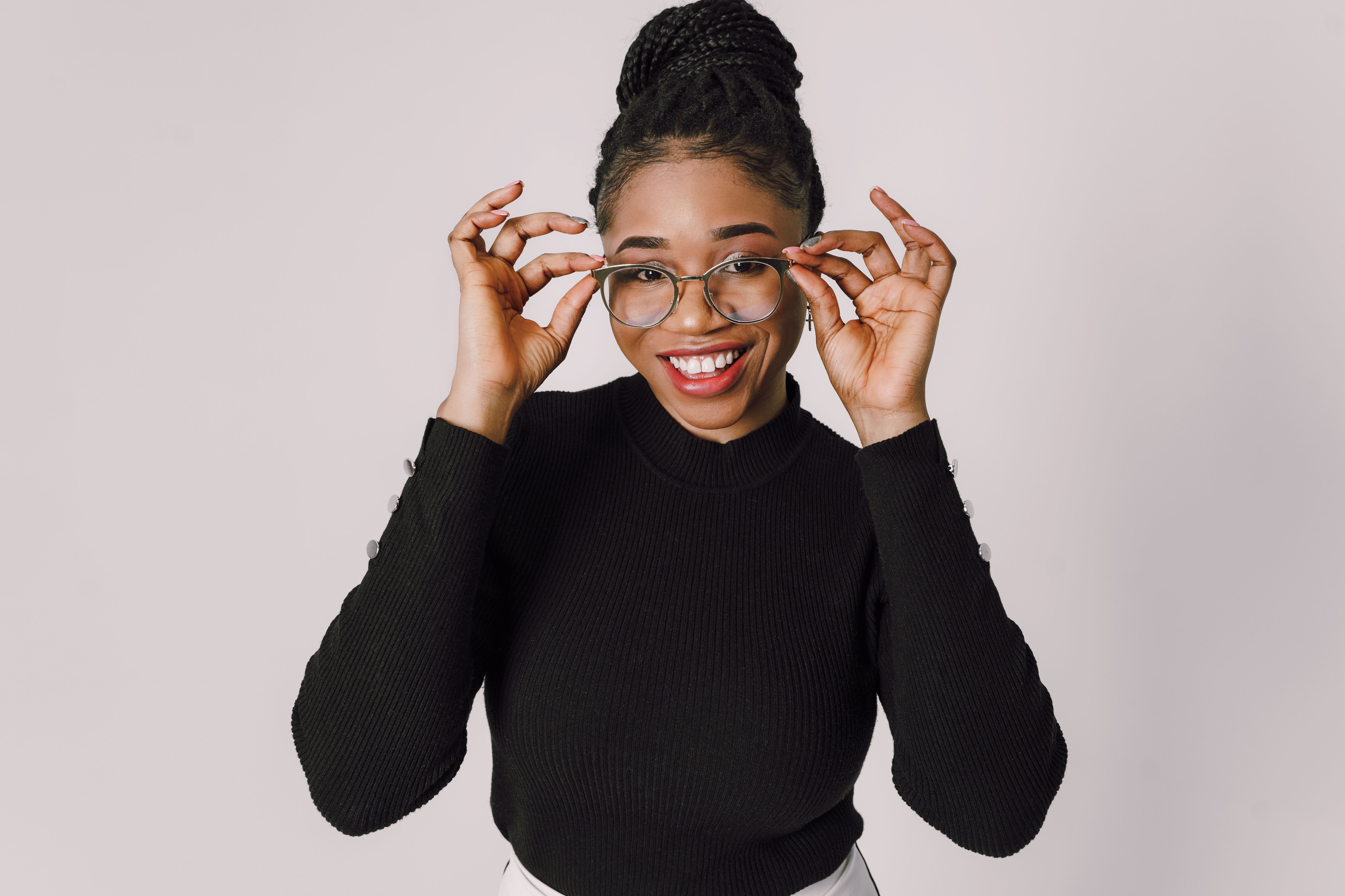 Woman Smiling, Sitting and Silencing · Free Stock Photo