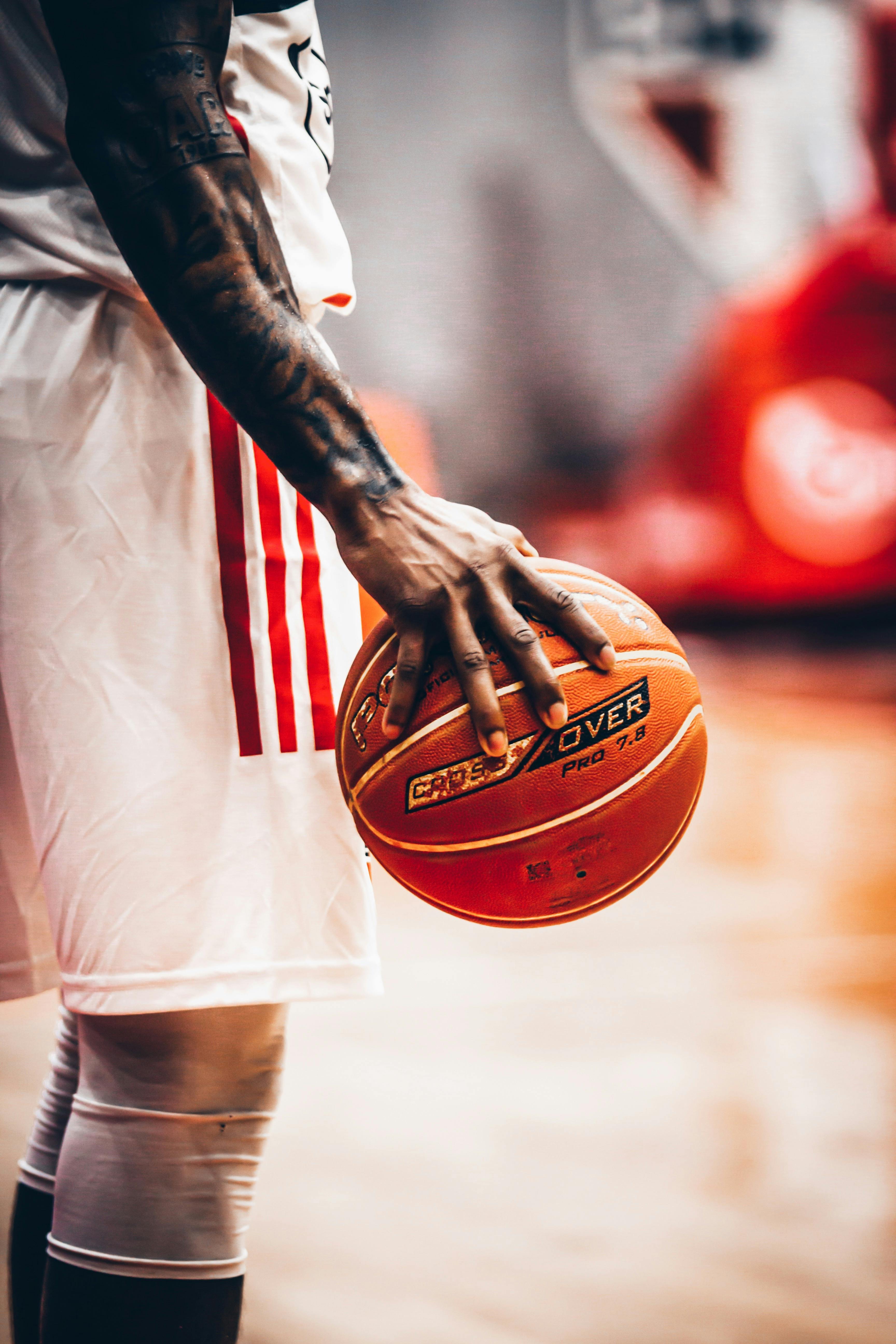 Basketball Player Holding the Ball with One Hand · Free Stock Photo