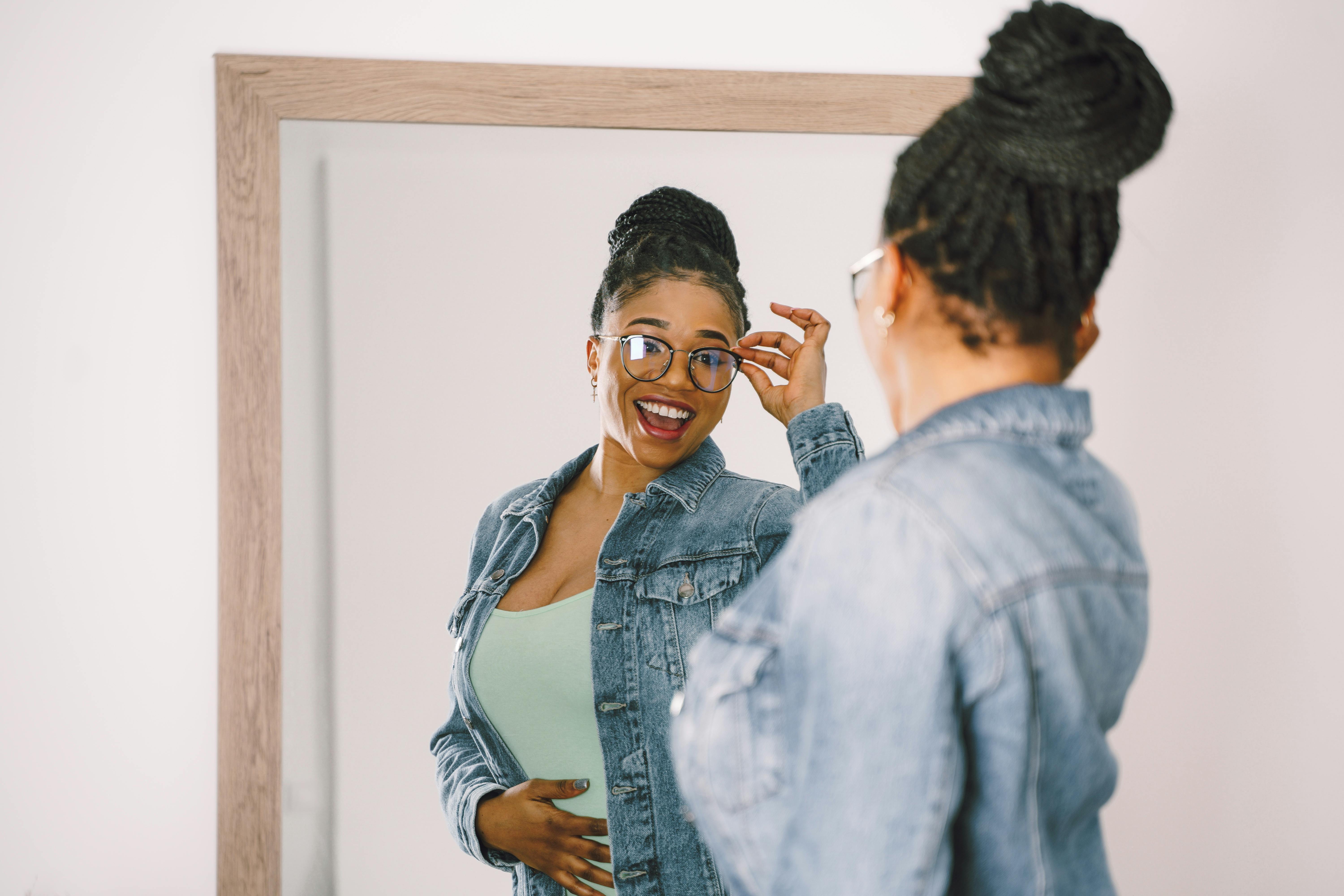 Reflection of Smiling Woman in Mirror · Free Stock Photo