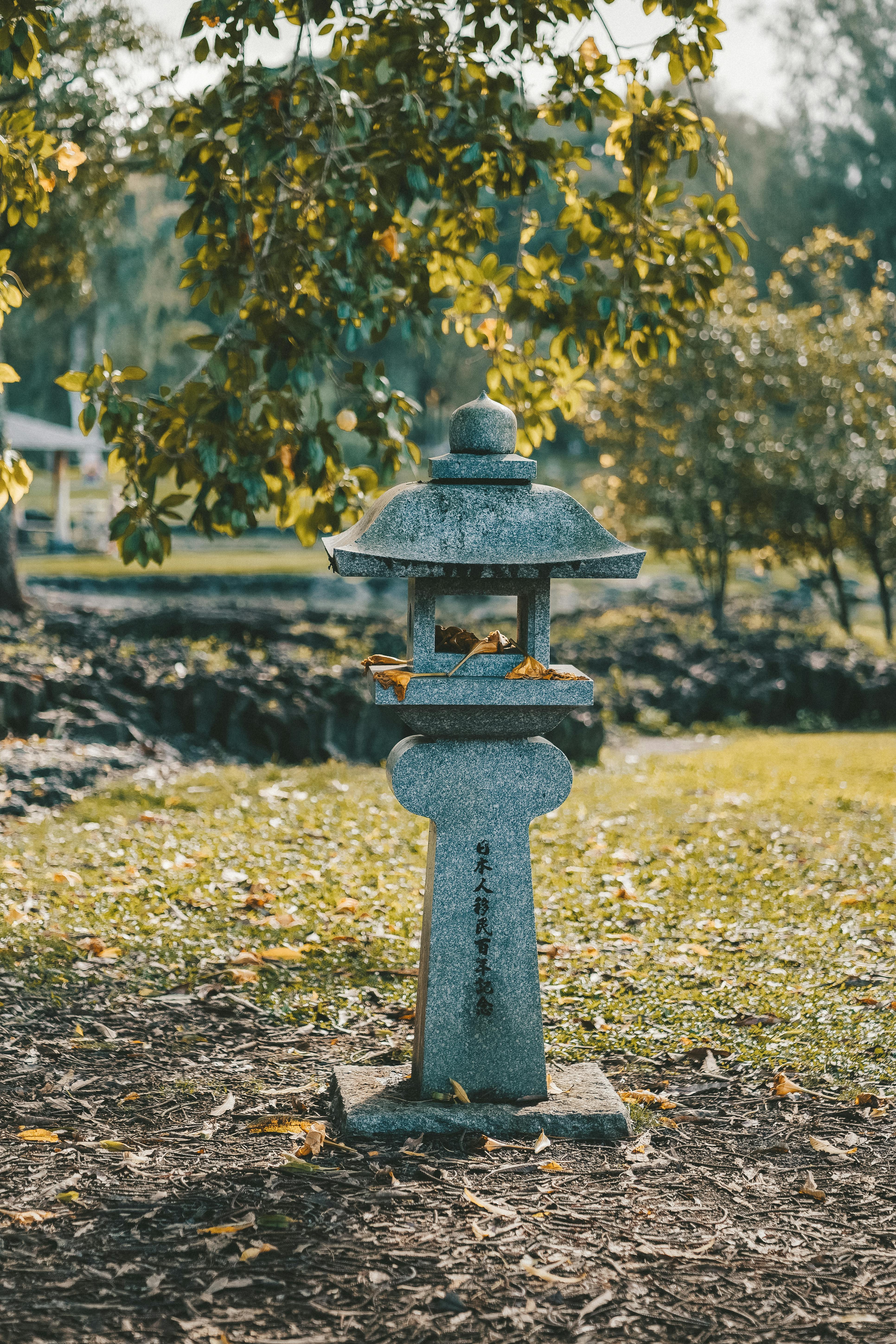 Japanese Style Stone Statue in a Garden · Free Stock Photo