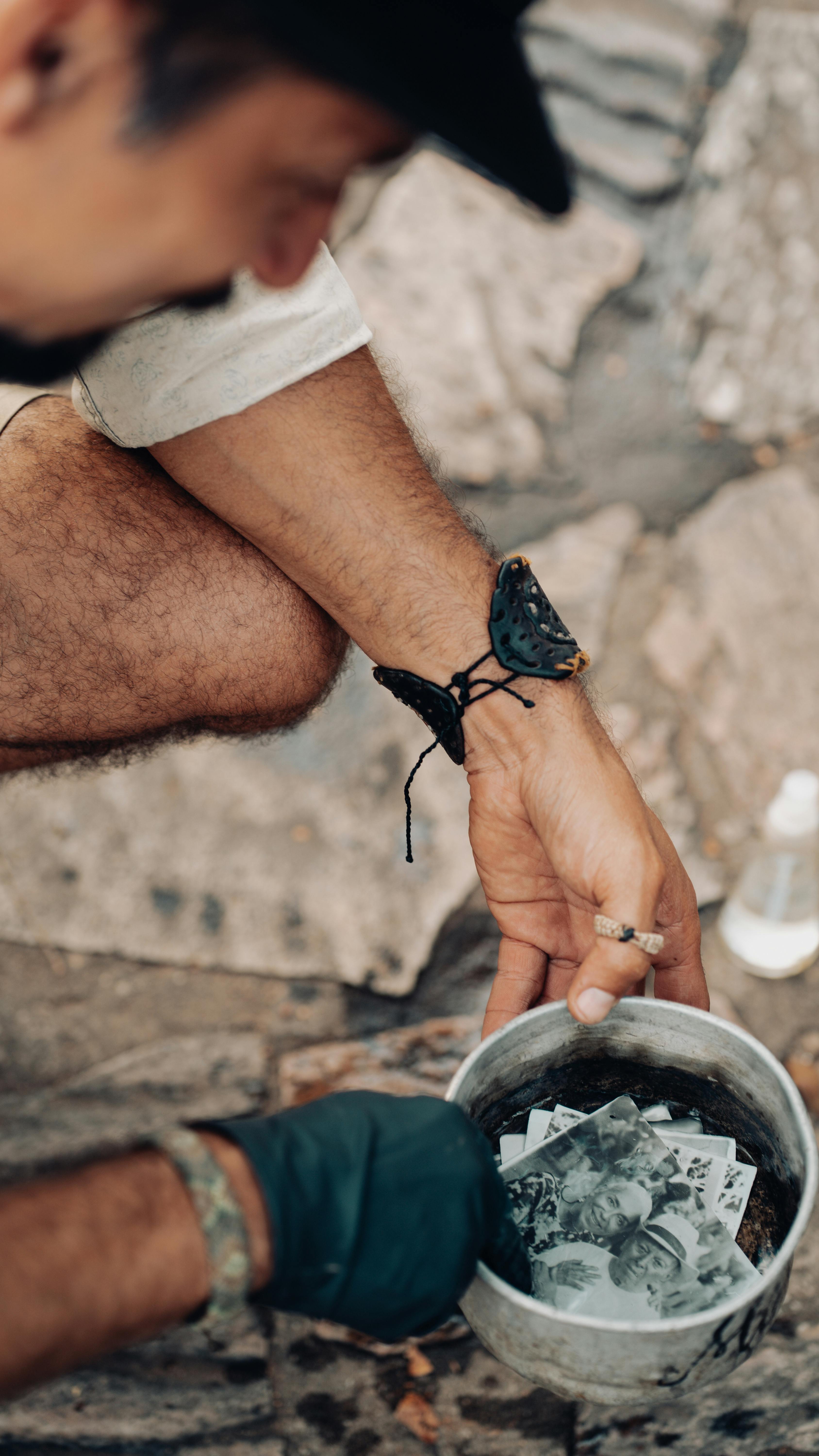 A Man with Photographs in a Container · Free Stock Photo