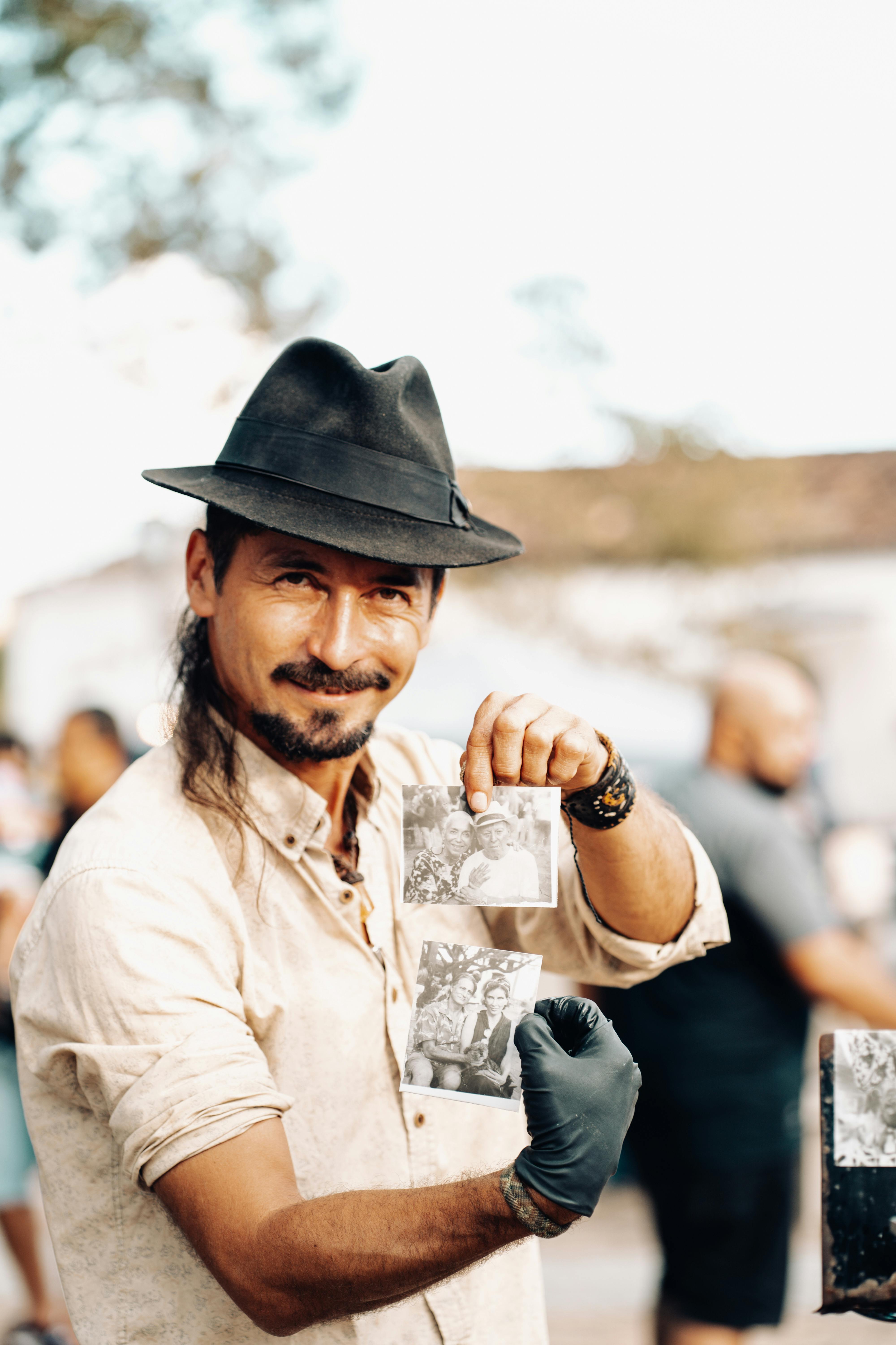 Man Showing Analog Photographies · Free Stock Photo