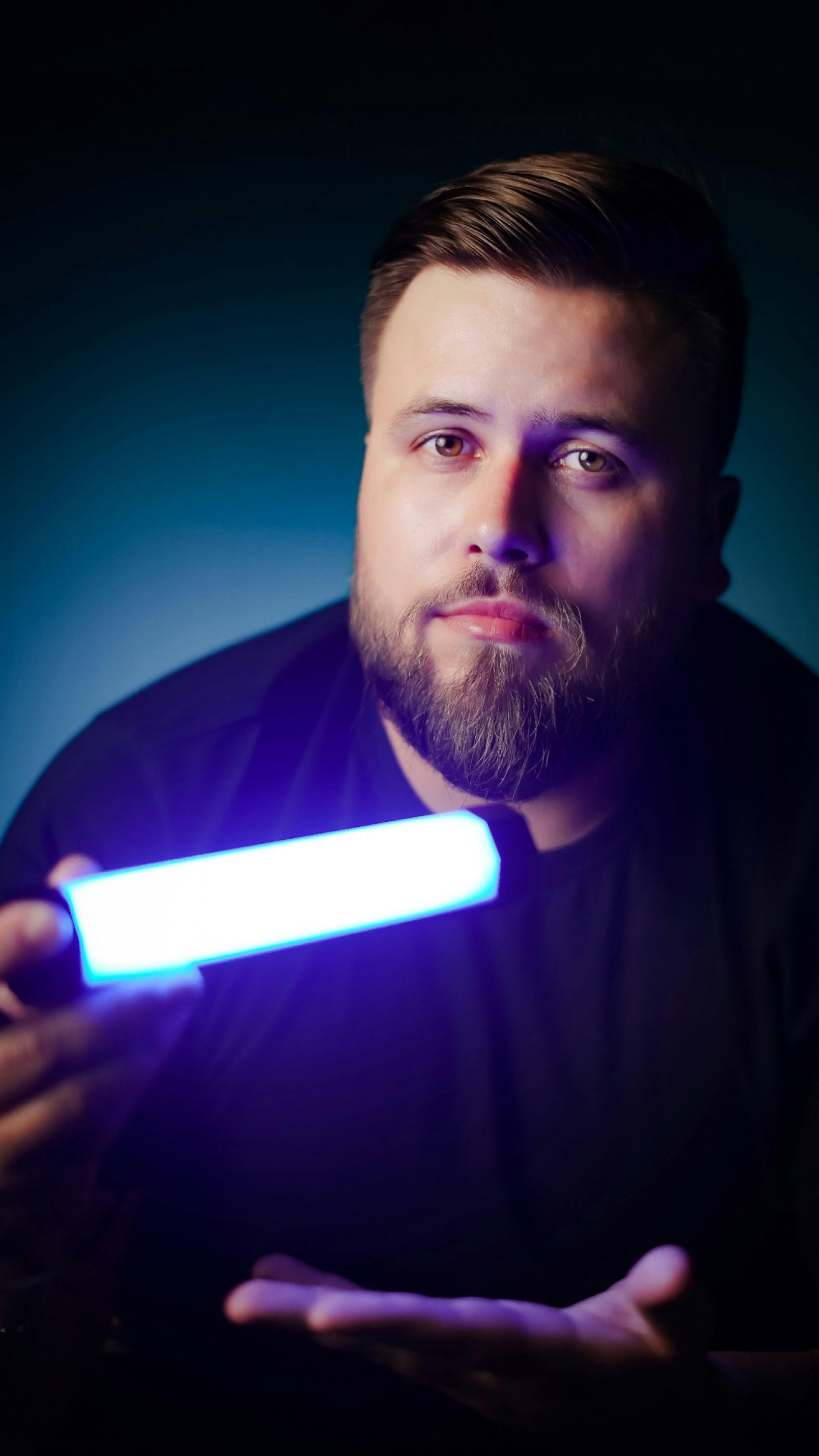 Man Holding a Tube Light · Free Stock Photo