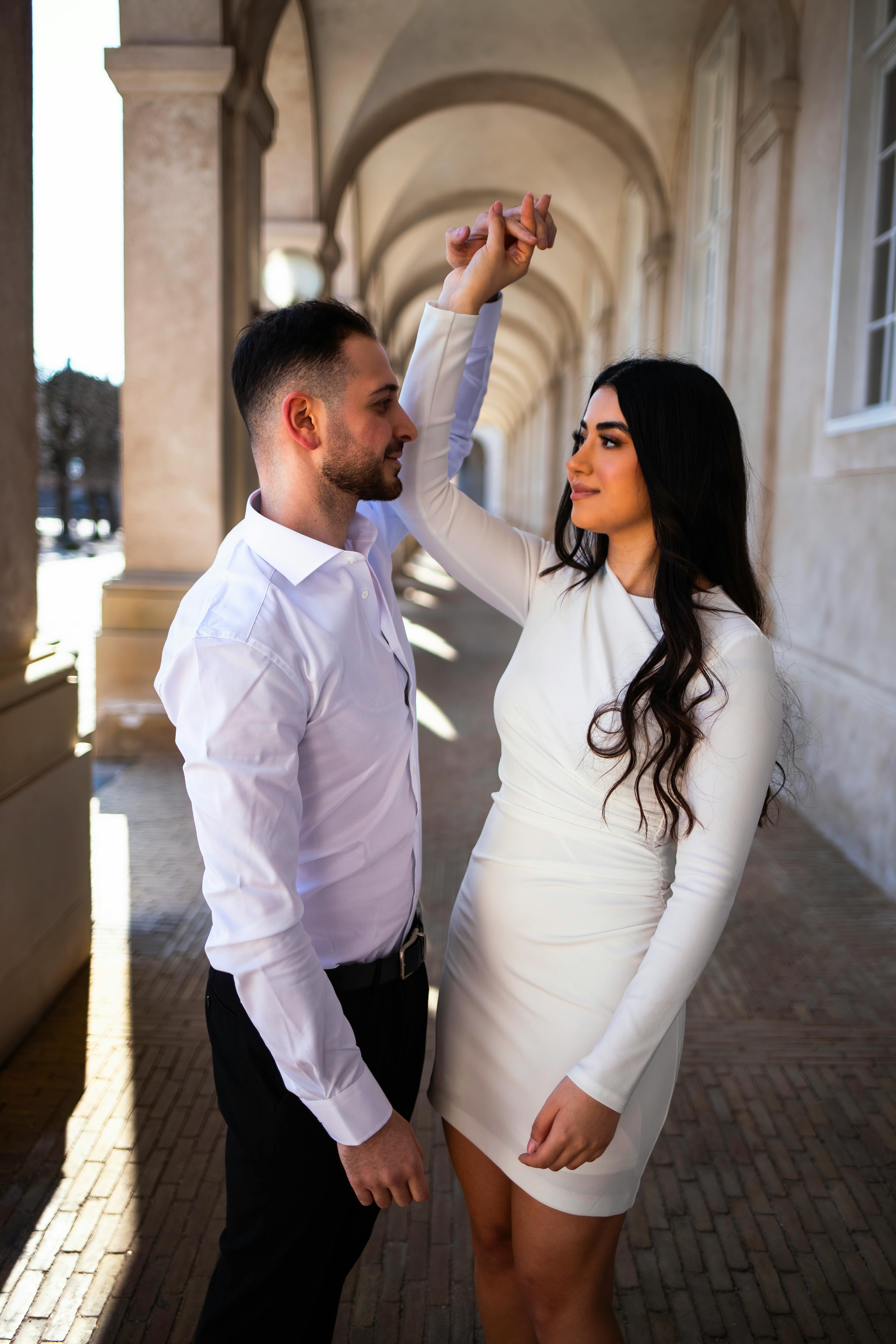 Couple Holding Raised Hands · Free Stock Photo