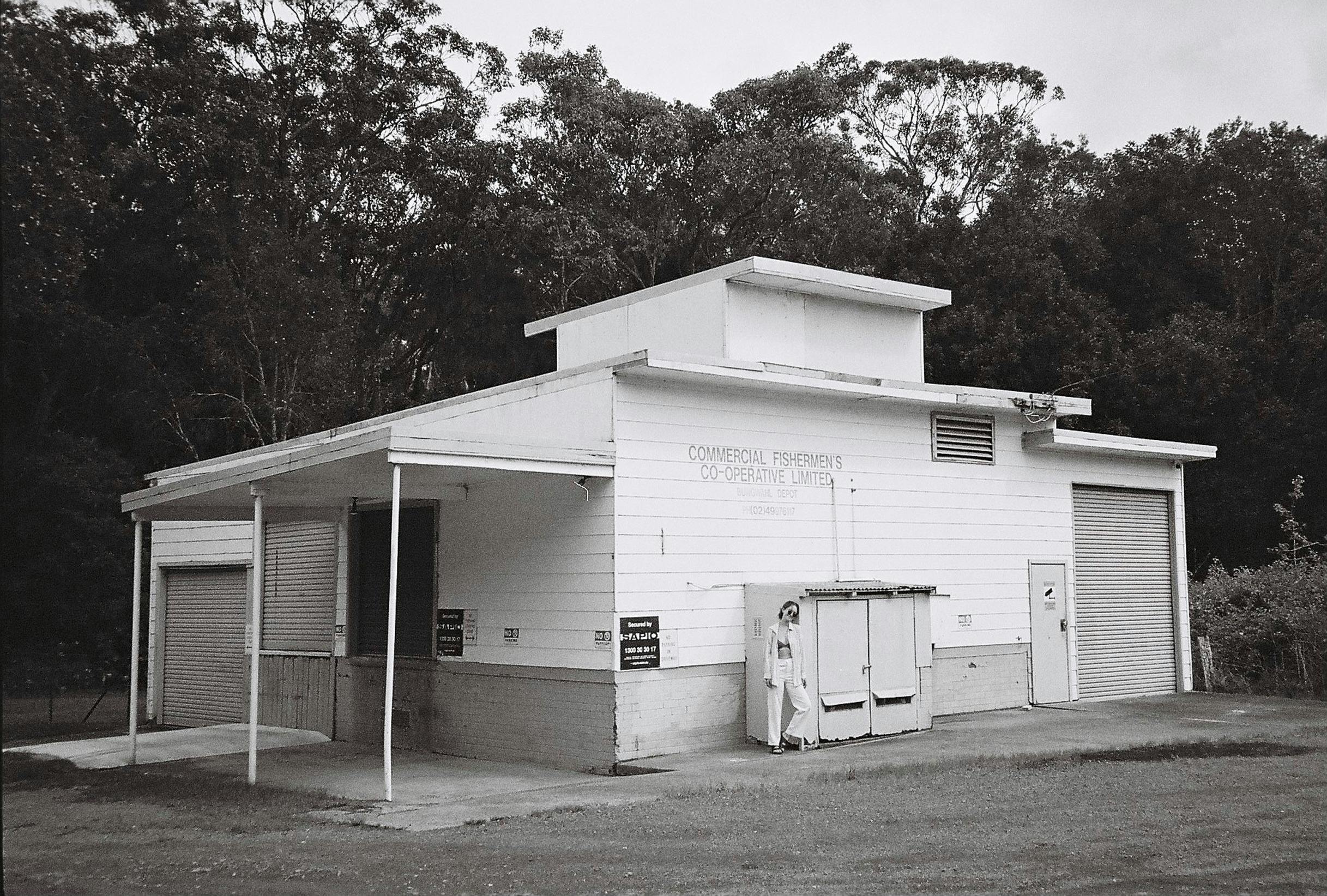 Woman Standing near Boxes on Building Wall in Black and White · Free ...
