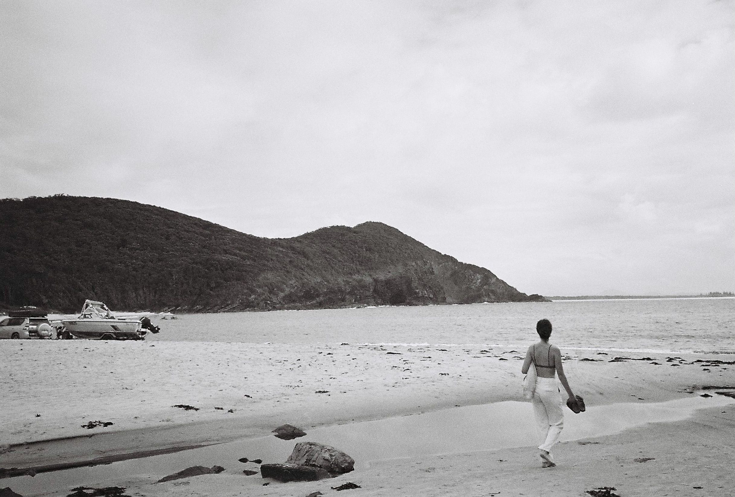 Black and White Picture of a Woman Walking on the Beach Alone · Free ...