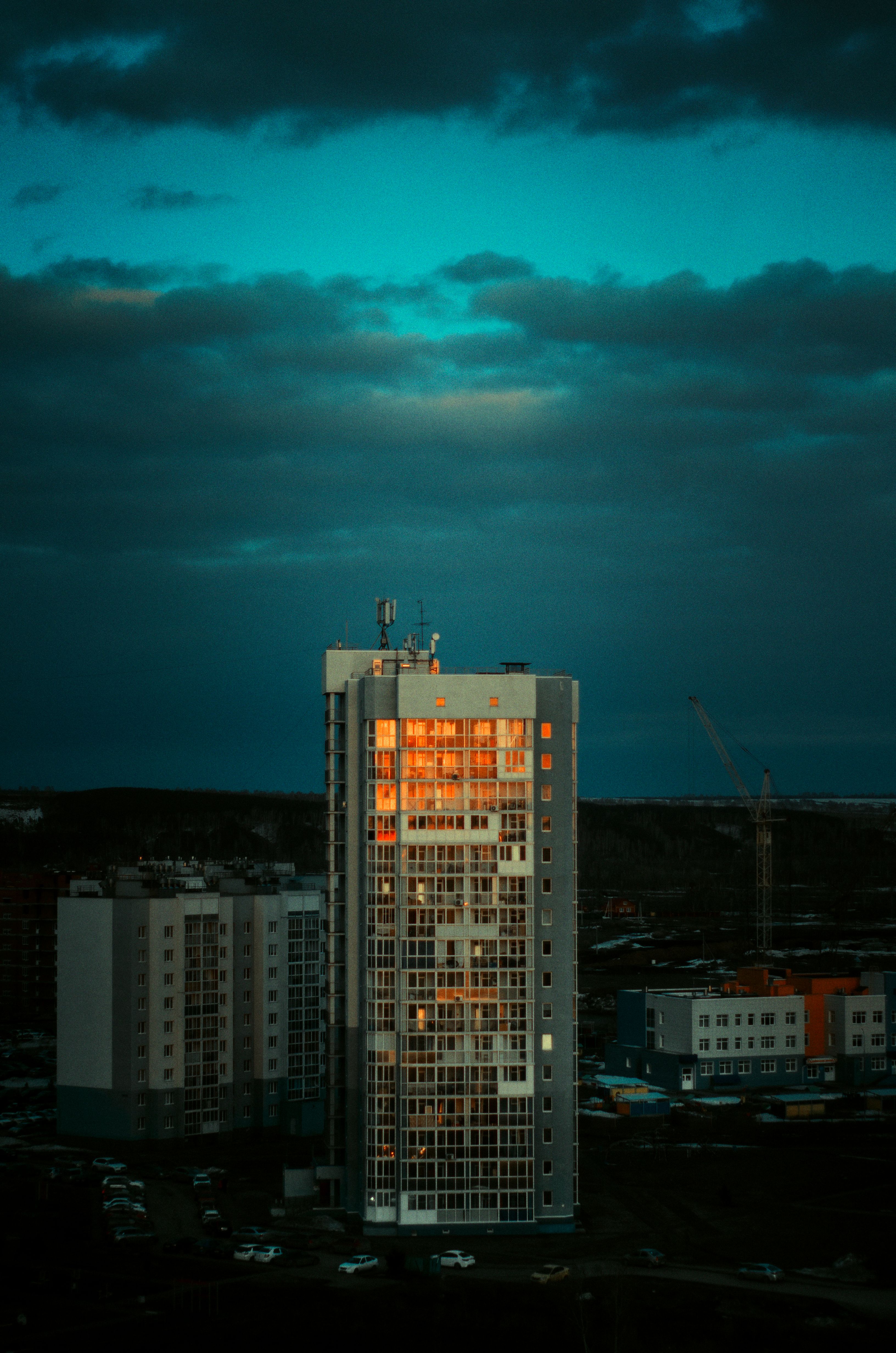 A Skyscraper Reflecting the Sunset on the Background of a Dark Sky ...