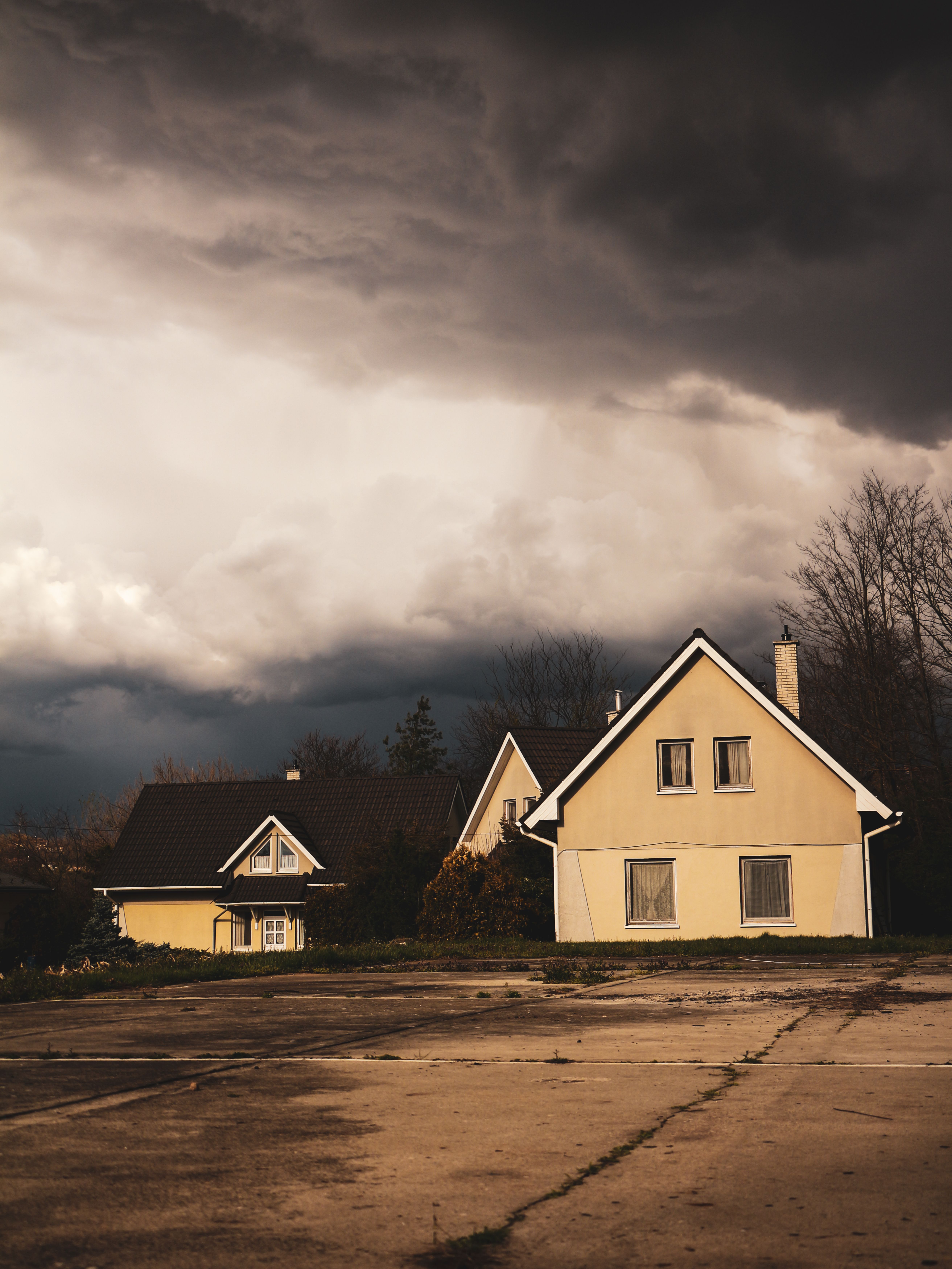 Black and White House Under Thick Clouds · Free Stock Photo