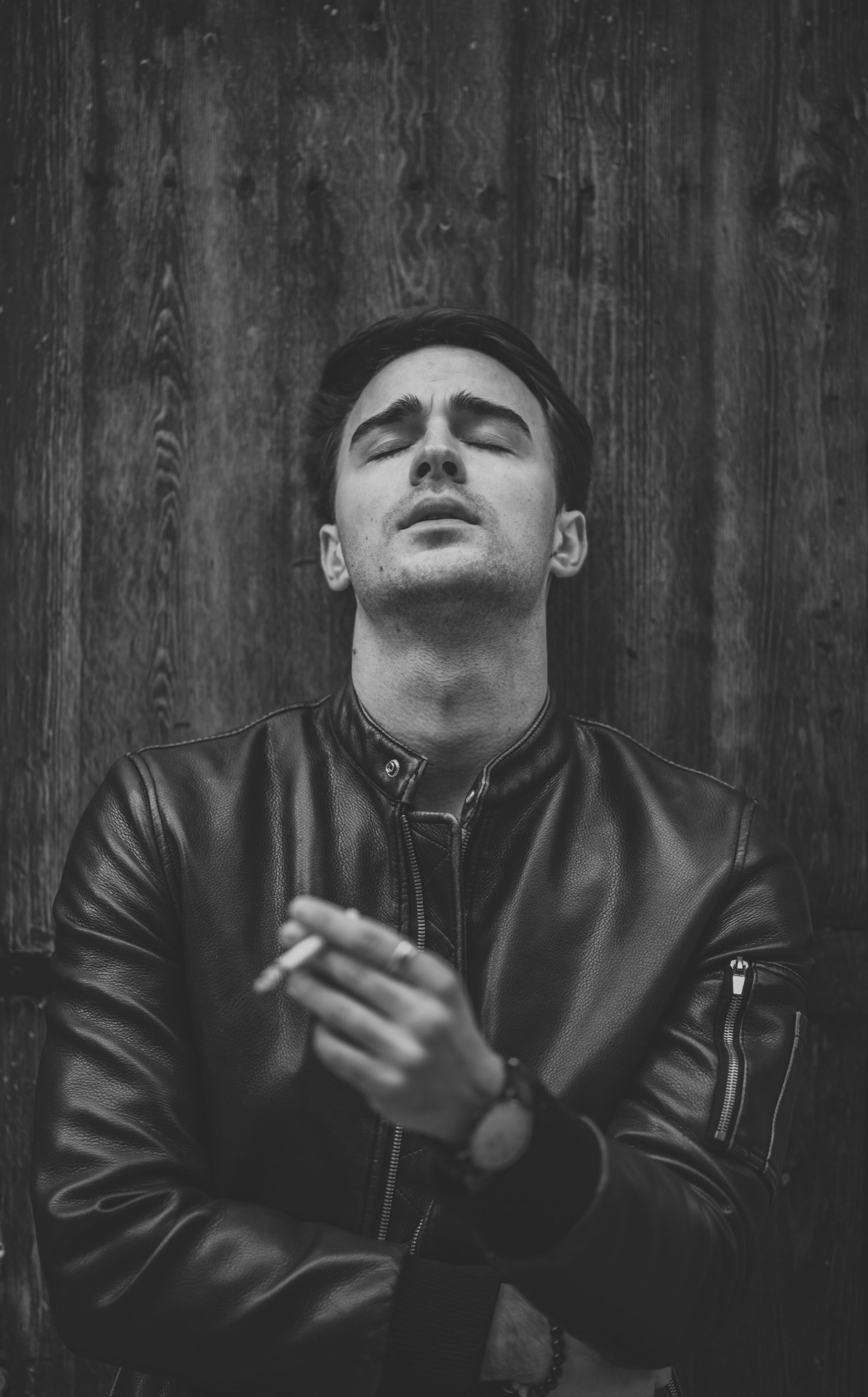 A man in a leather jacket smoking · Free Stock Photo