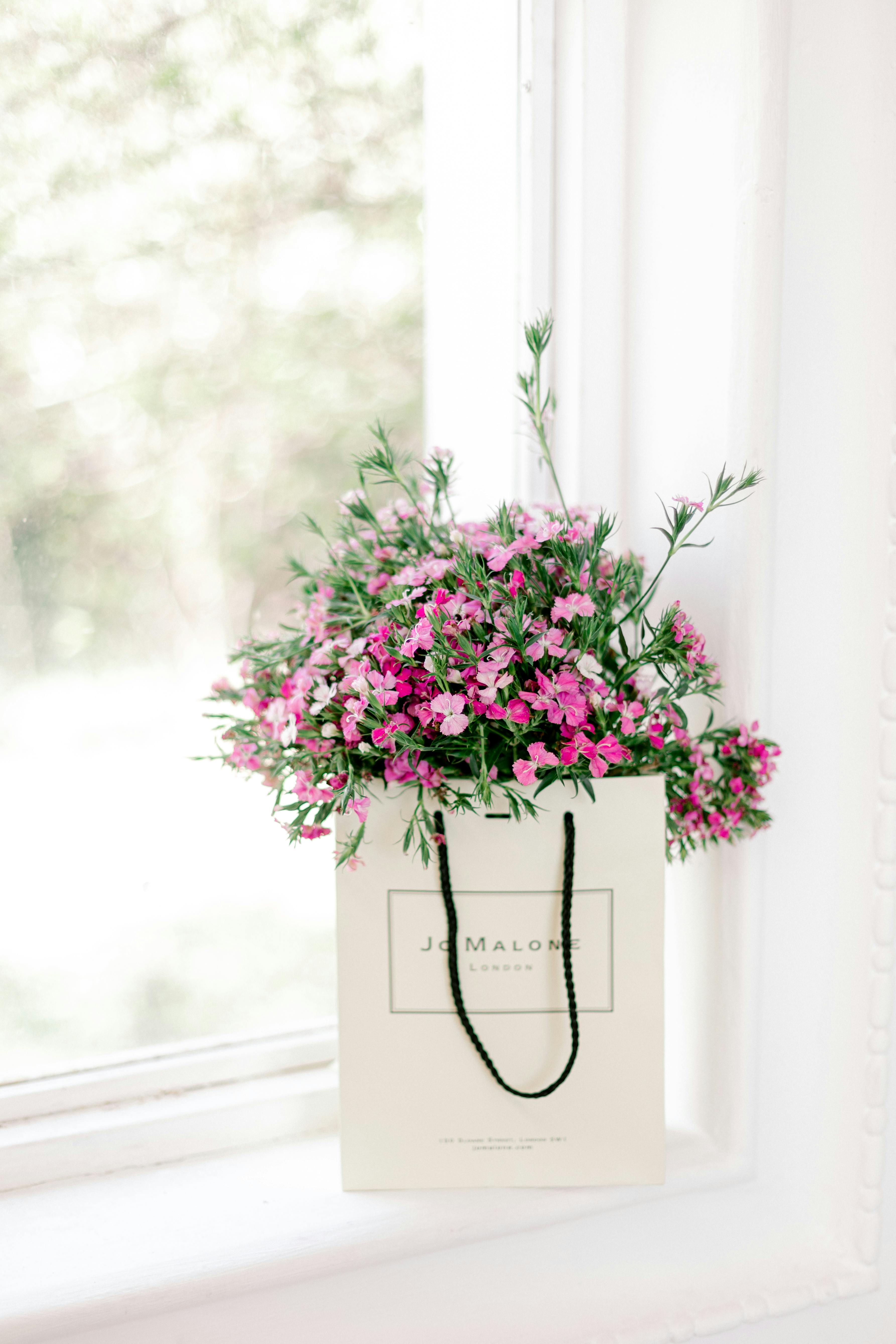 Bag with Flowers on Windowsill · Free Stock Photo