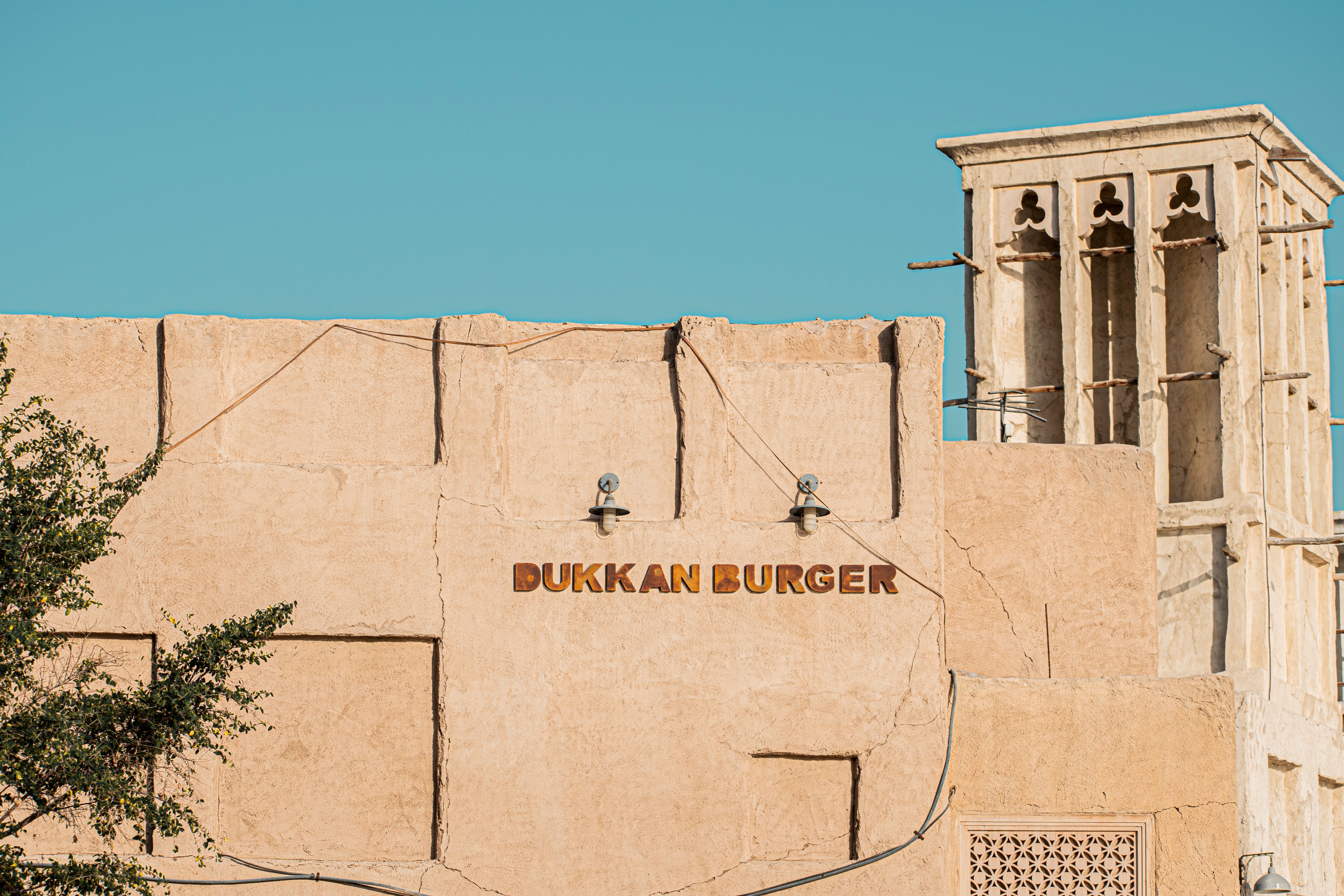 Text on Building Wall with Tower near · Free Stock Photo