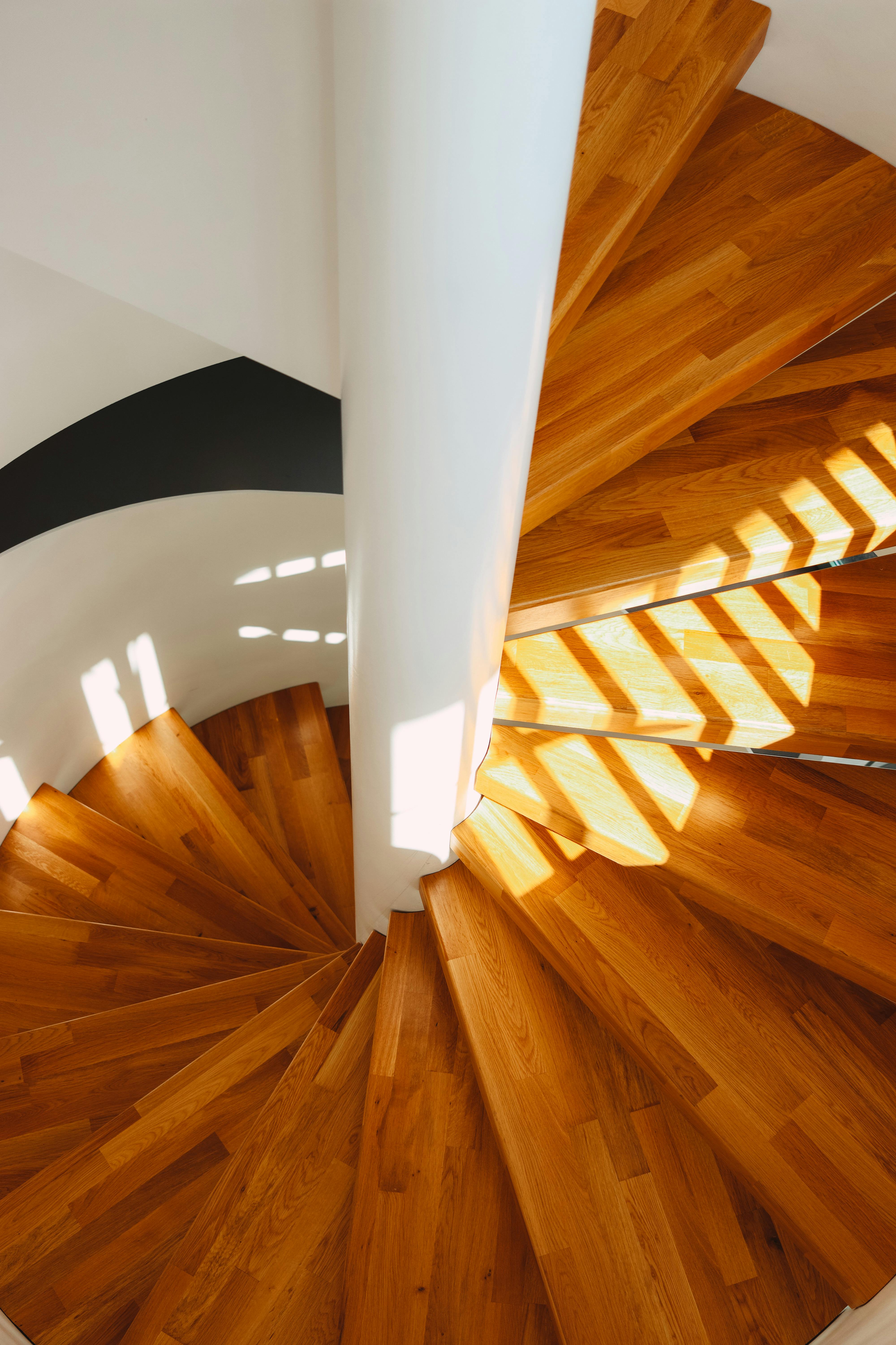 Person Standing Below A Spiral Staircase · Free Stock Photo