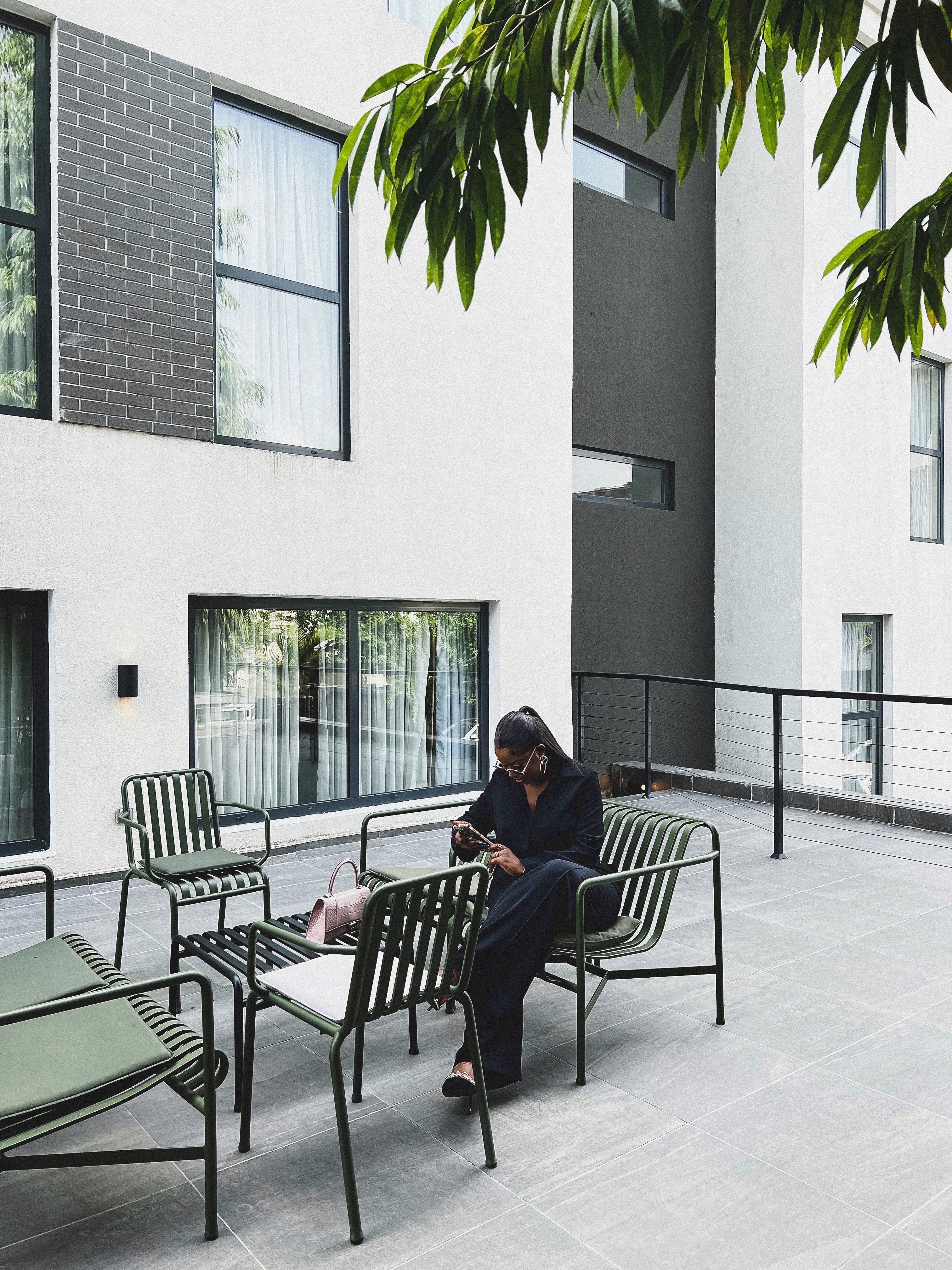 Woman Sitting on a Terrace of a Modern Residential Building · Free ...