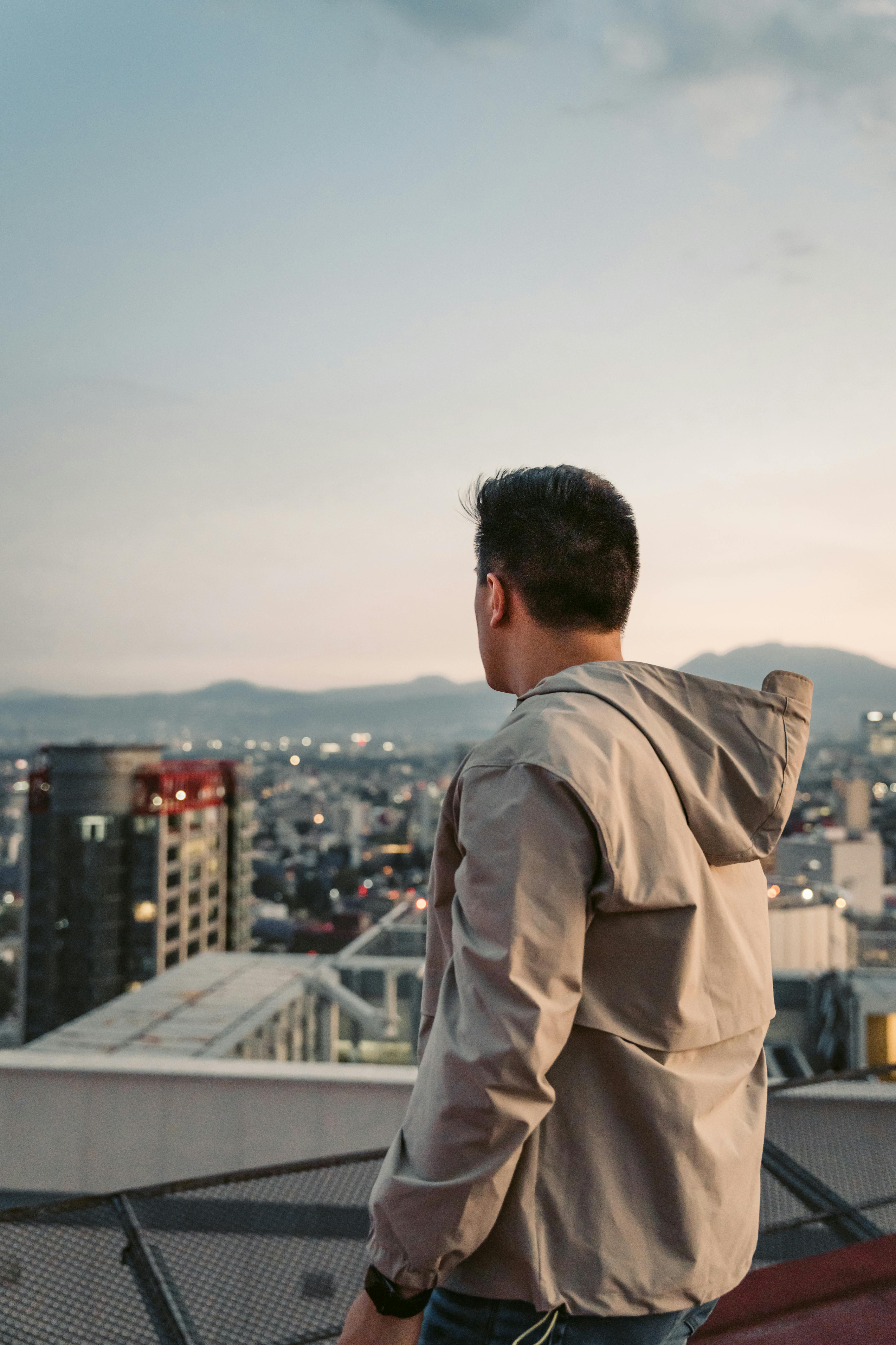 Man Standing on a Rooftop · Free Stock Photo