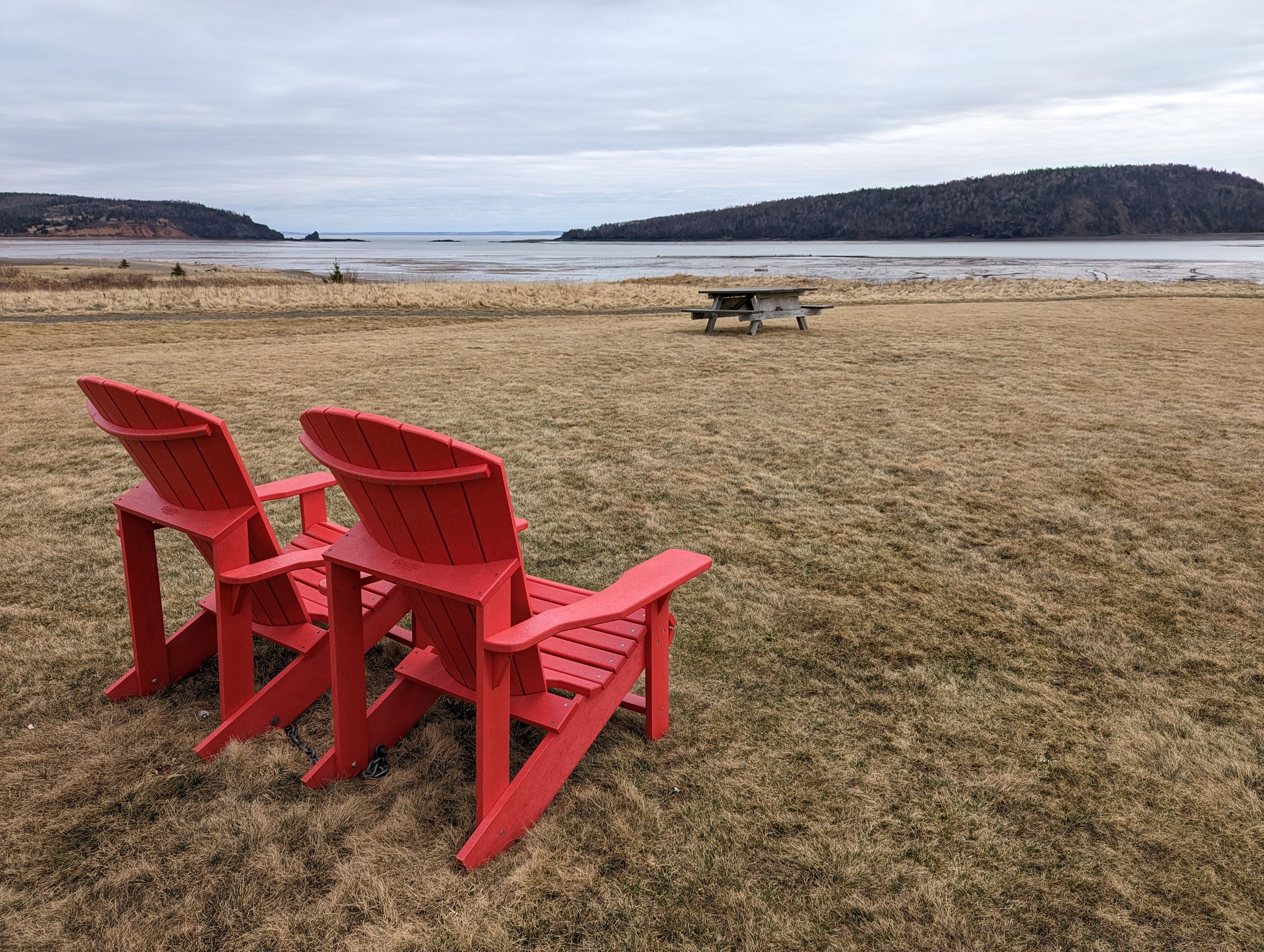 Two Red Chairs Standing on a Beach · Free Stock Photo