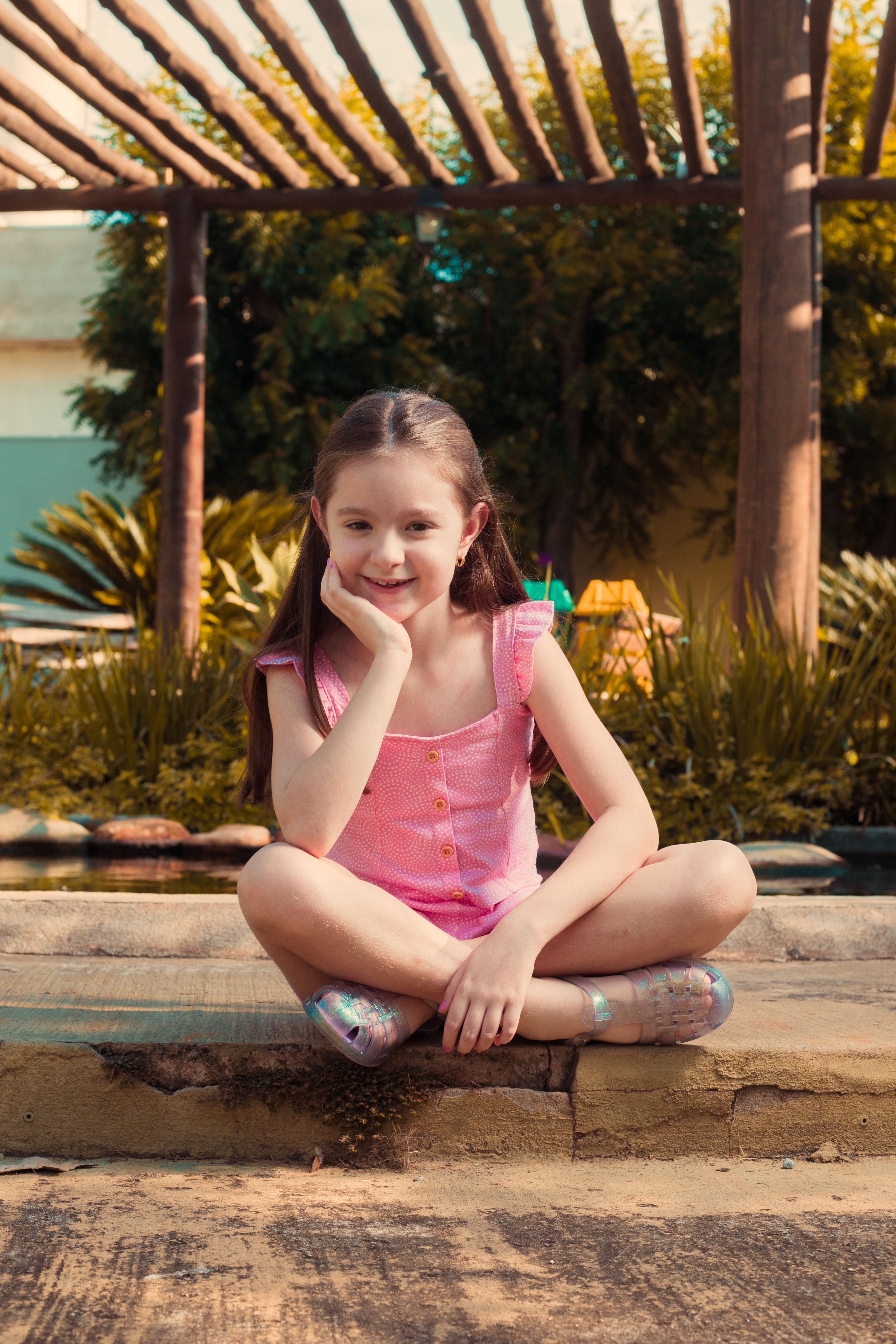 Girl Sitting on Pavement and Smiling · Free Stock Photo