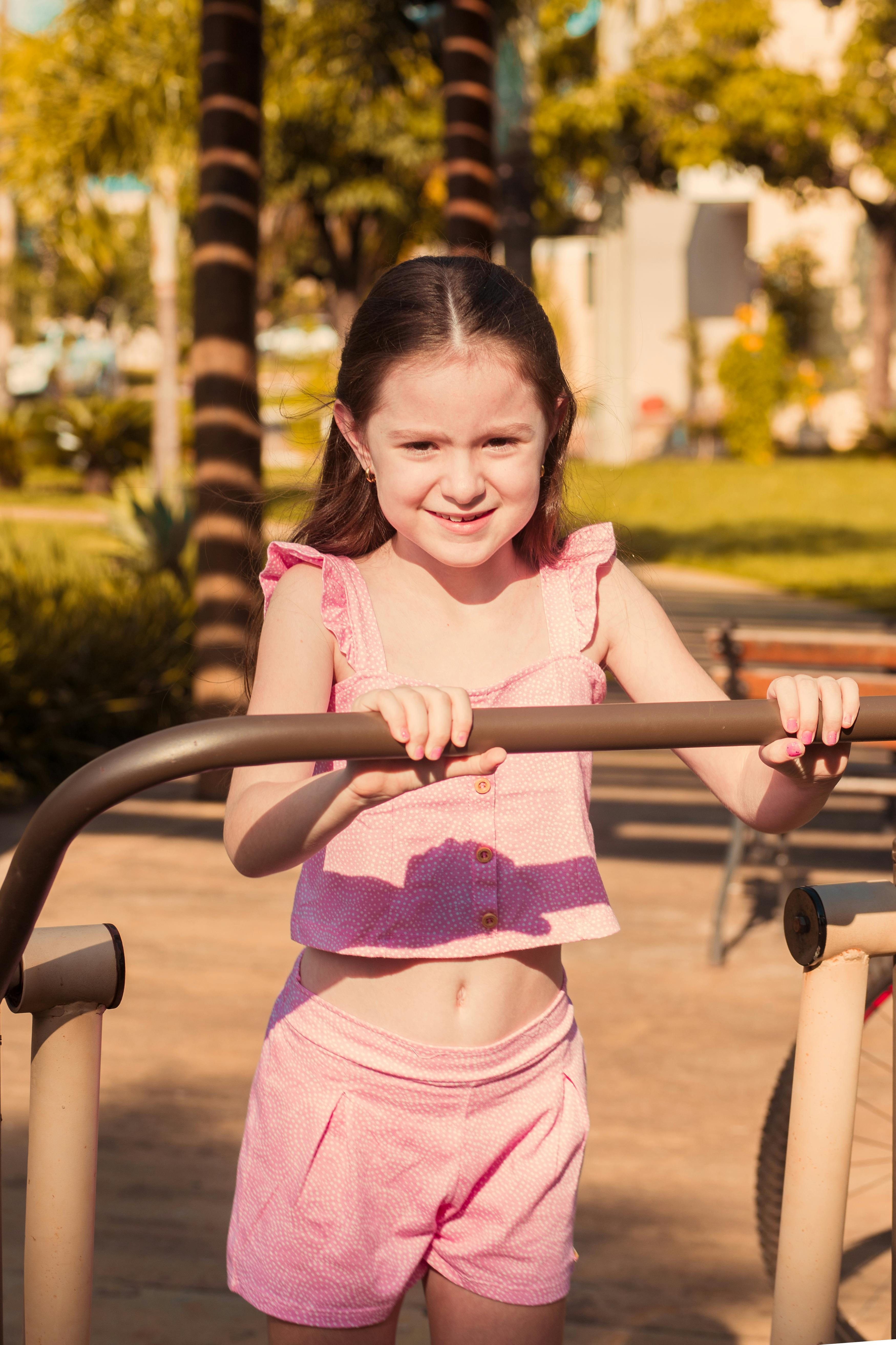 A Girl Touching the Clothes Hanging on the Clothesline · Free Stock Photo