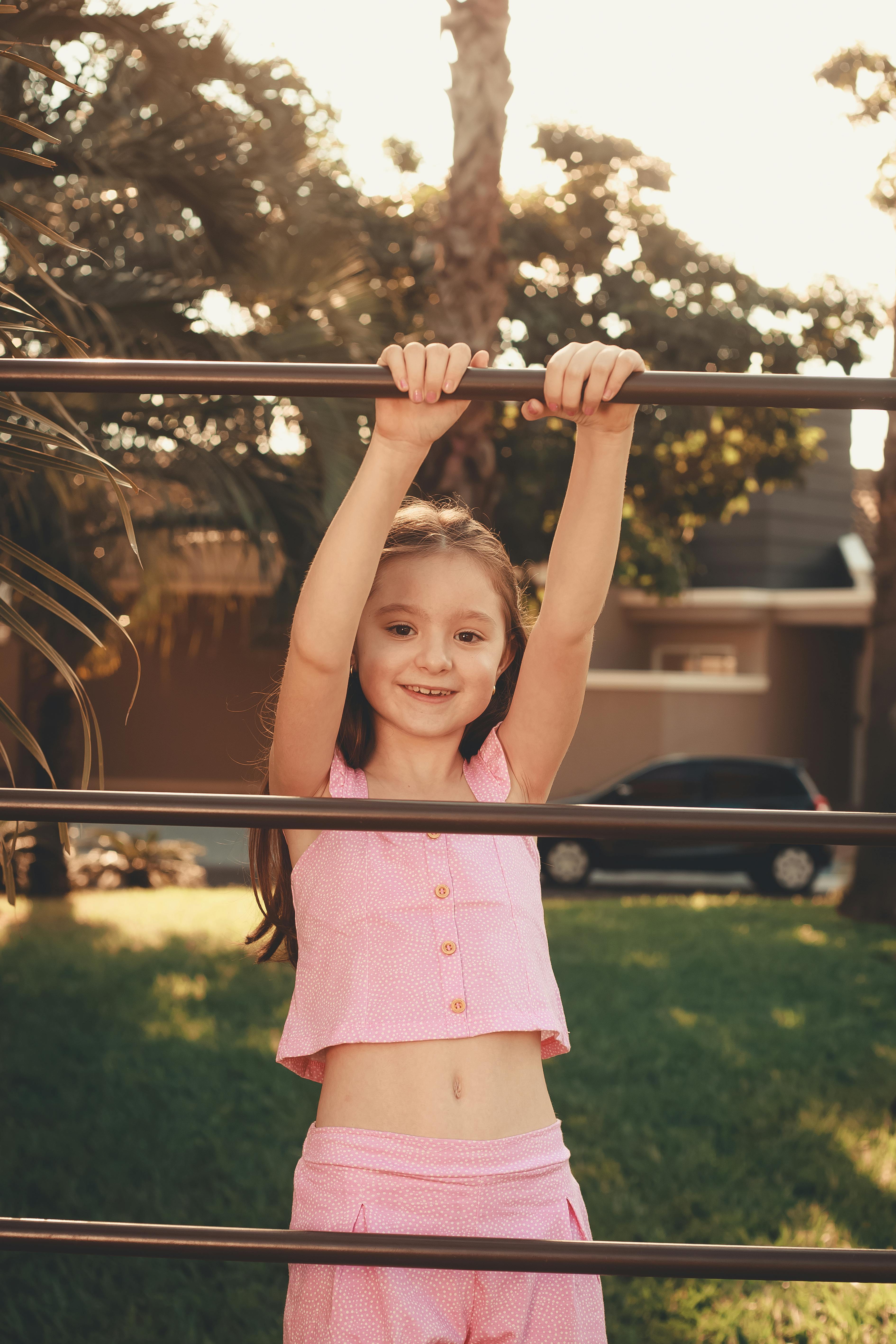 Girl Posing with Arms Raised · Free Stock Photo