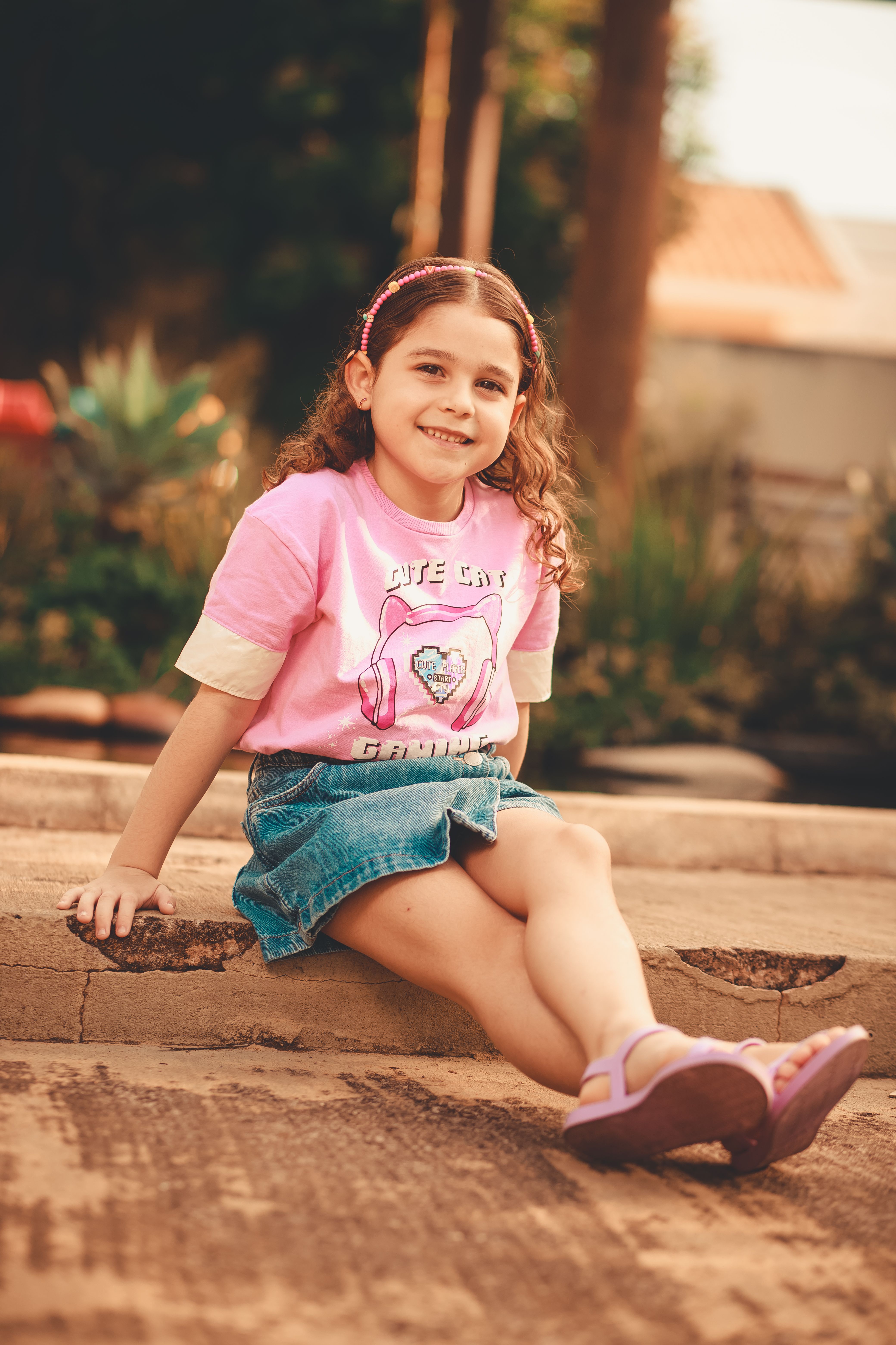 Girl Sitting on Pavement and Smiling · Free Stock Photo