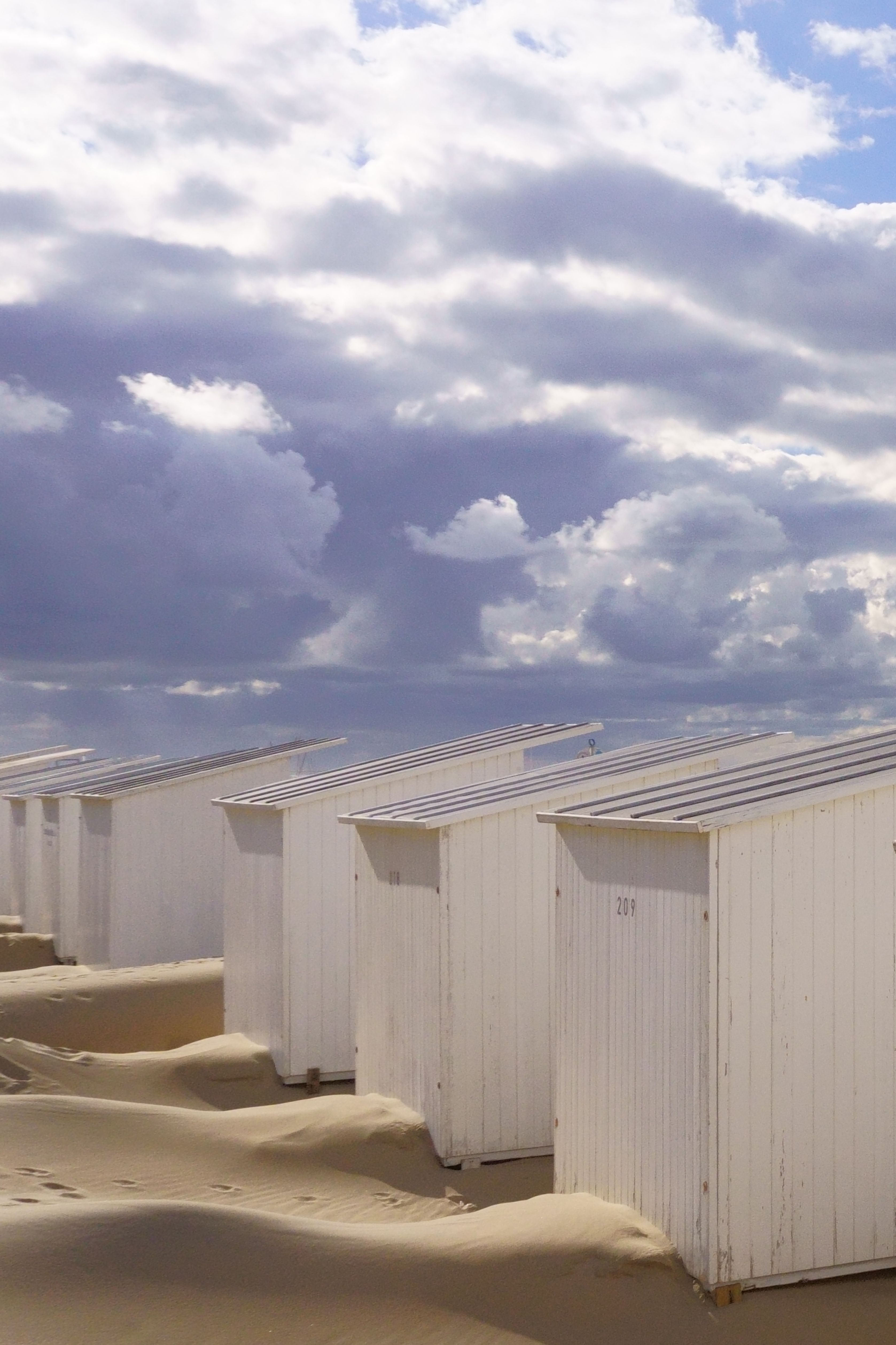 Row of White Sheds on Beach · Free Stock Photo