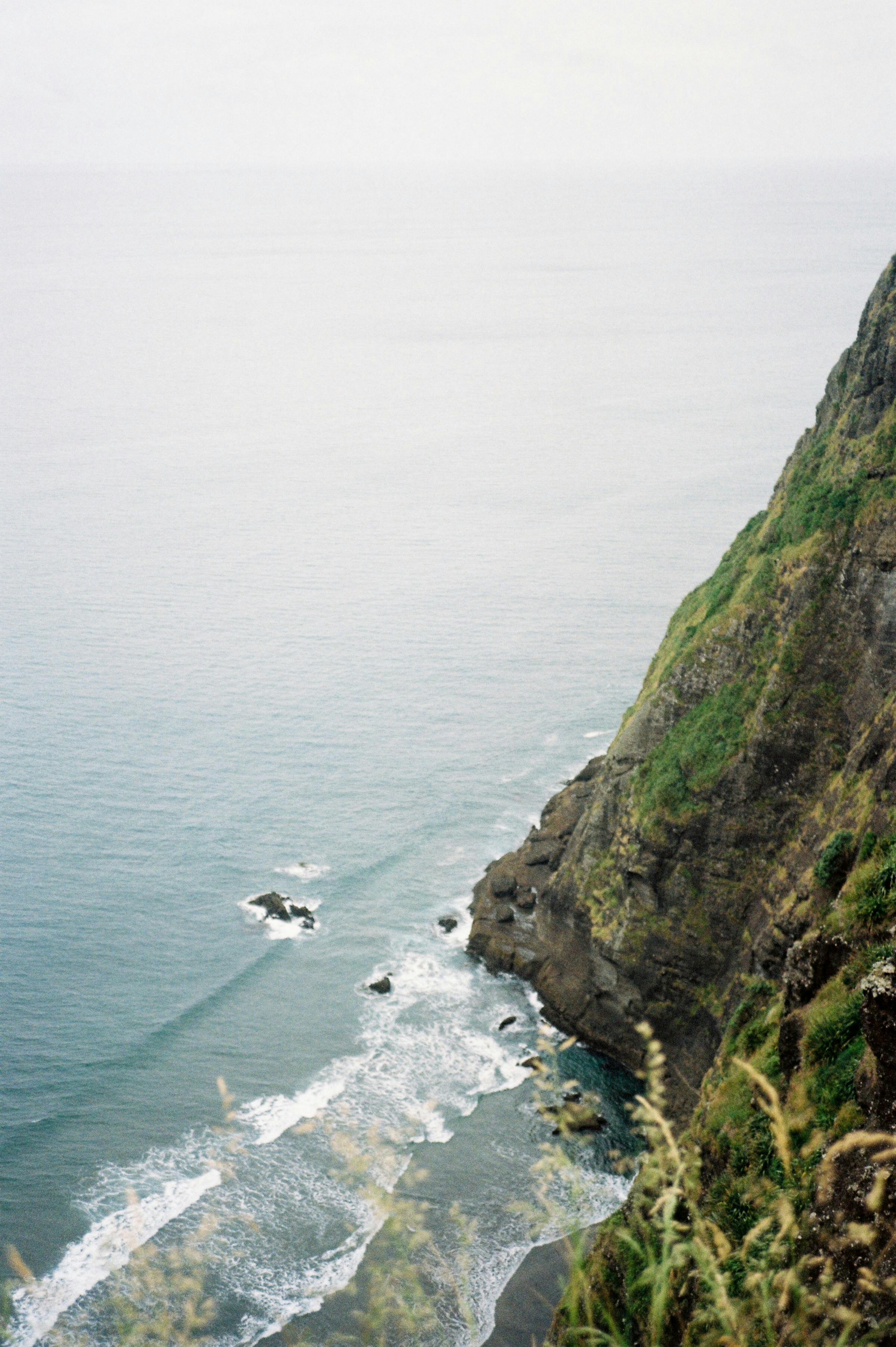 Aerial View of Waves Washing up the Shore and a High Cliff · Free Stock ...