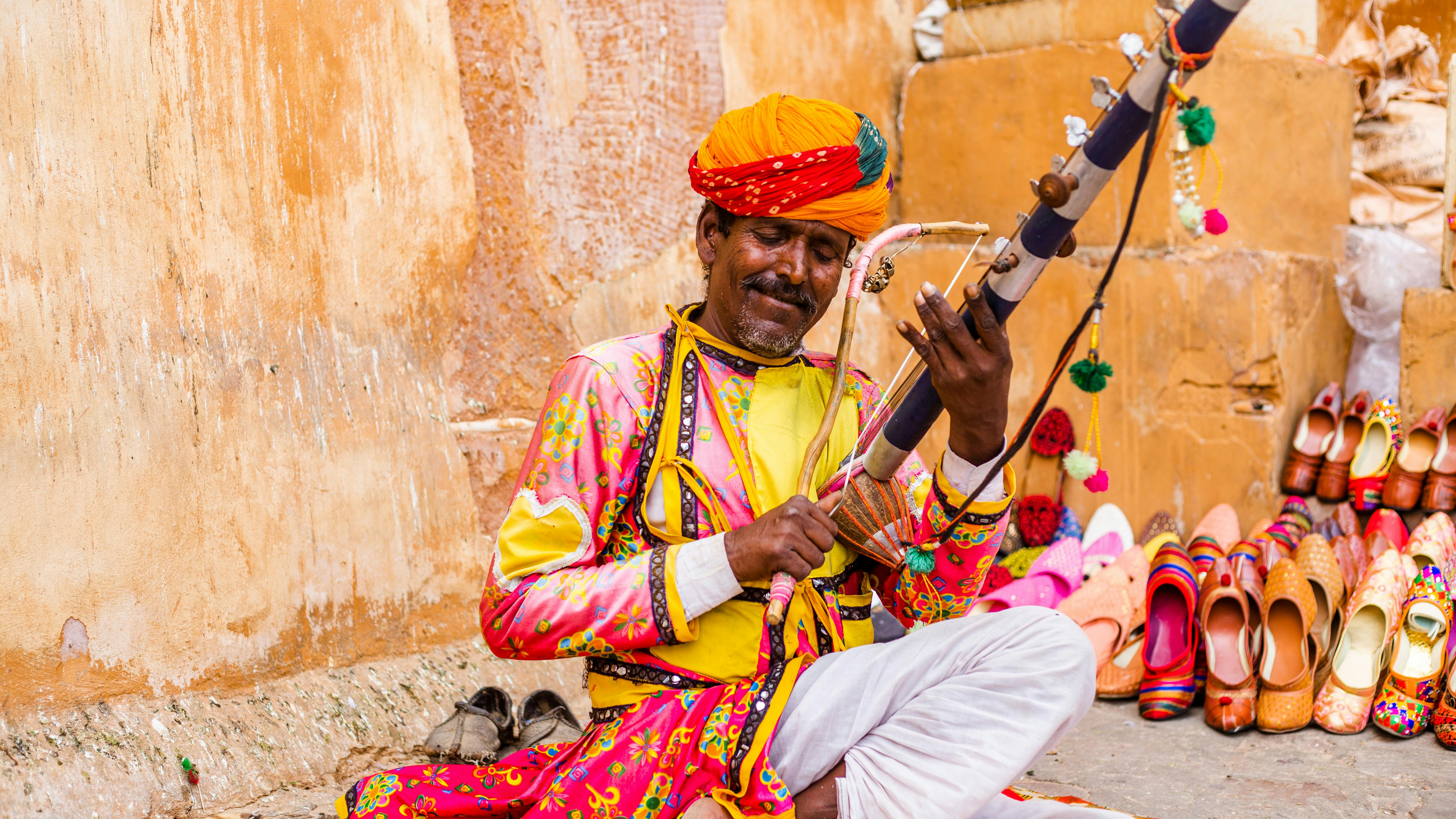 A man in traditional clothing playing a musical instrument · Free Stock ...