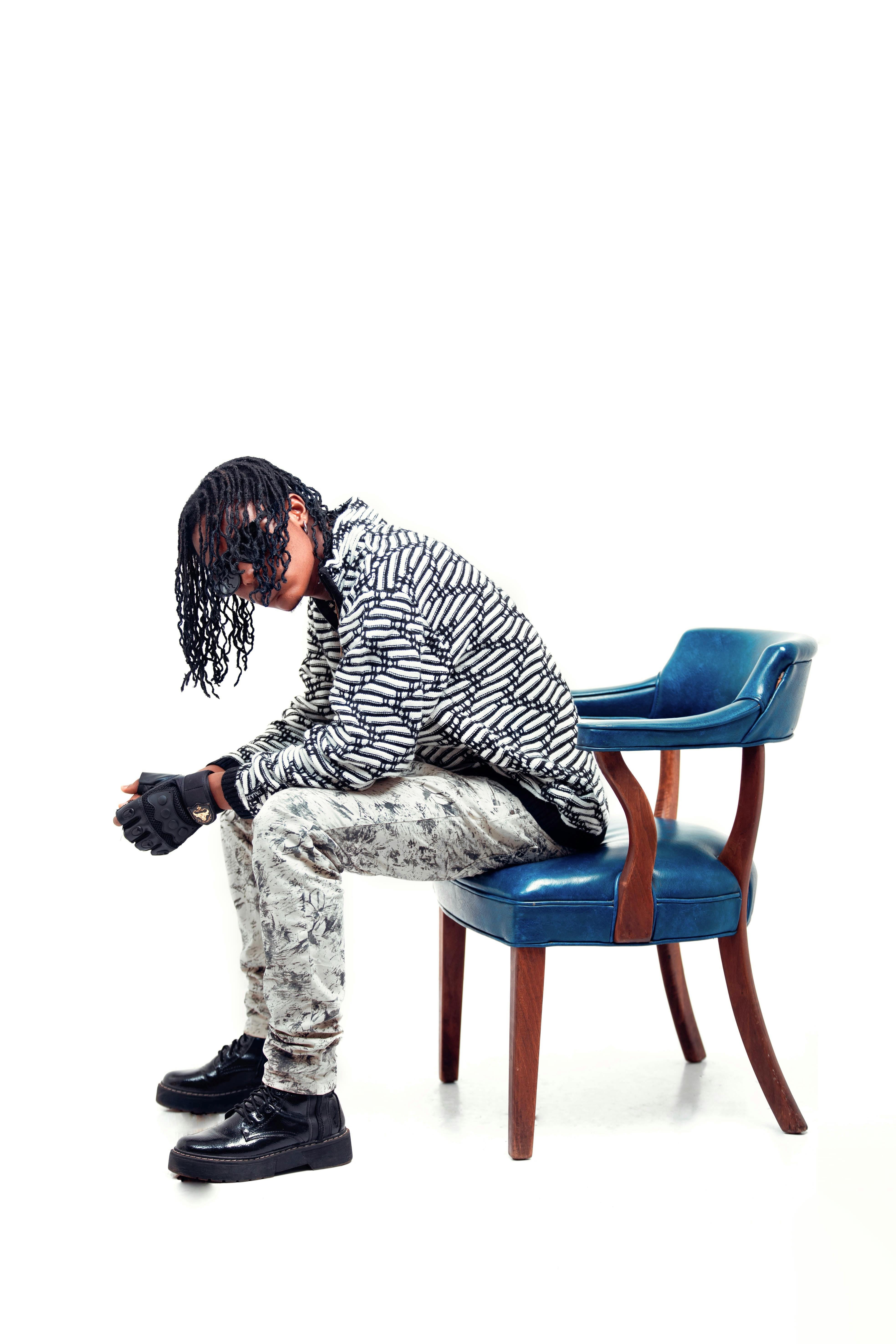 Person Sitting on Chair and Posing · Free Stock Photo