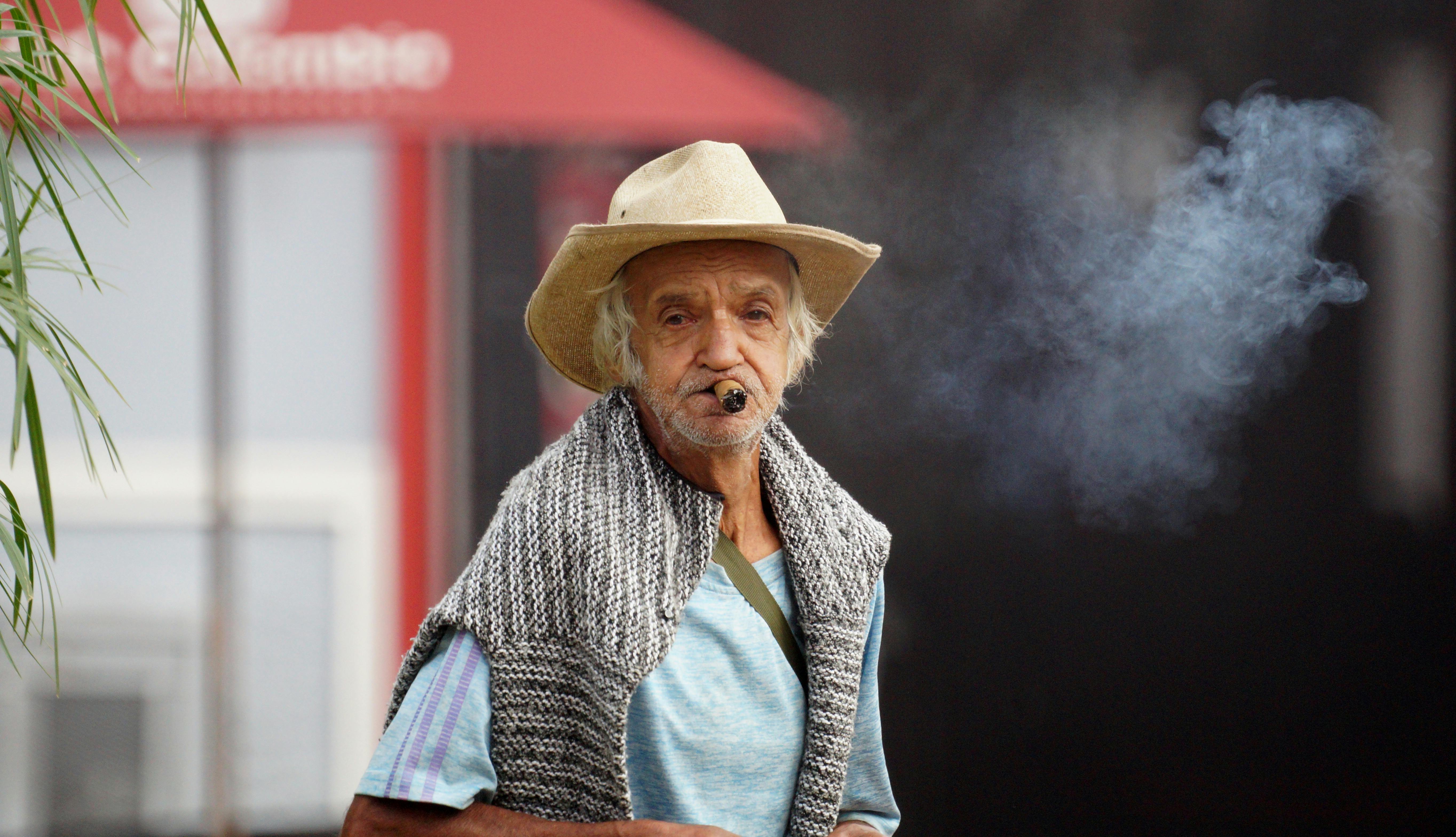 Grayscale Photo of an Elderly Woman Smoking a Cigarette · Free Stock Photo