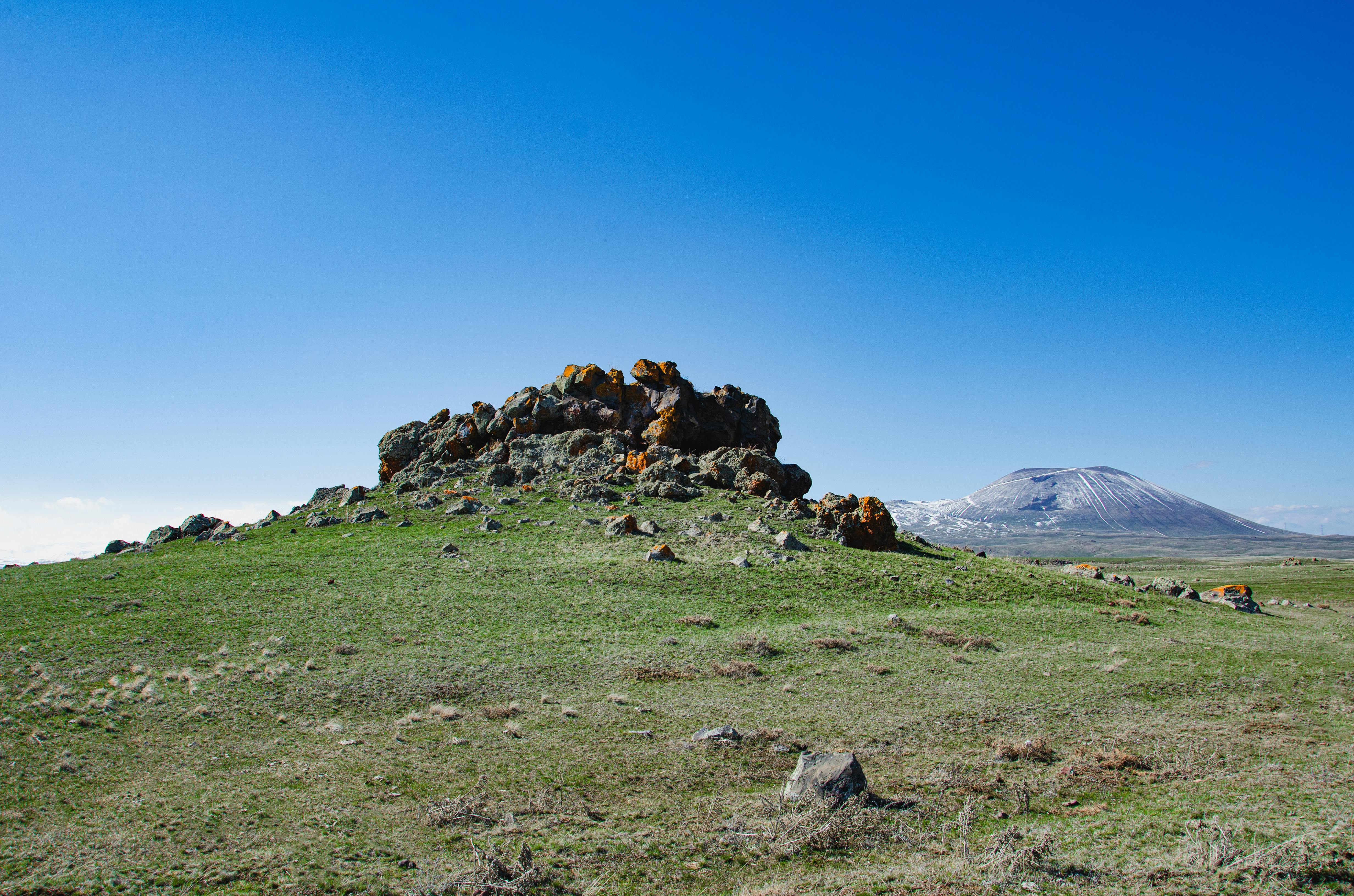 A Rock Formation on the Hill under a Clear Blue Sky · Free Stock Photo