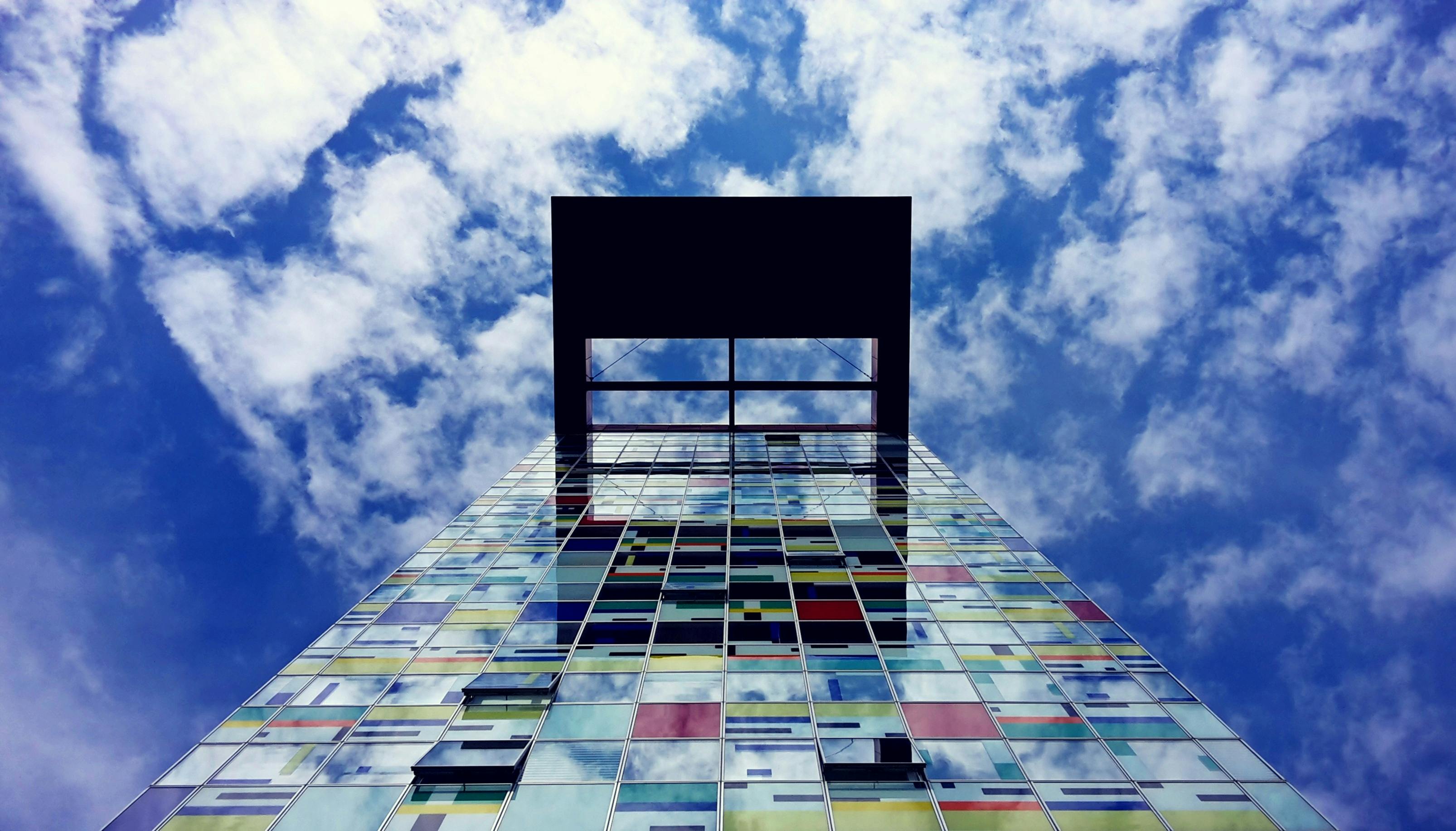 Gray and Black Concrete Tower Under White and Blue Sky · Free Stock Photo