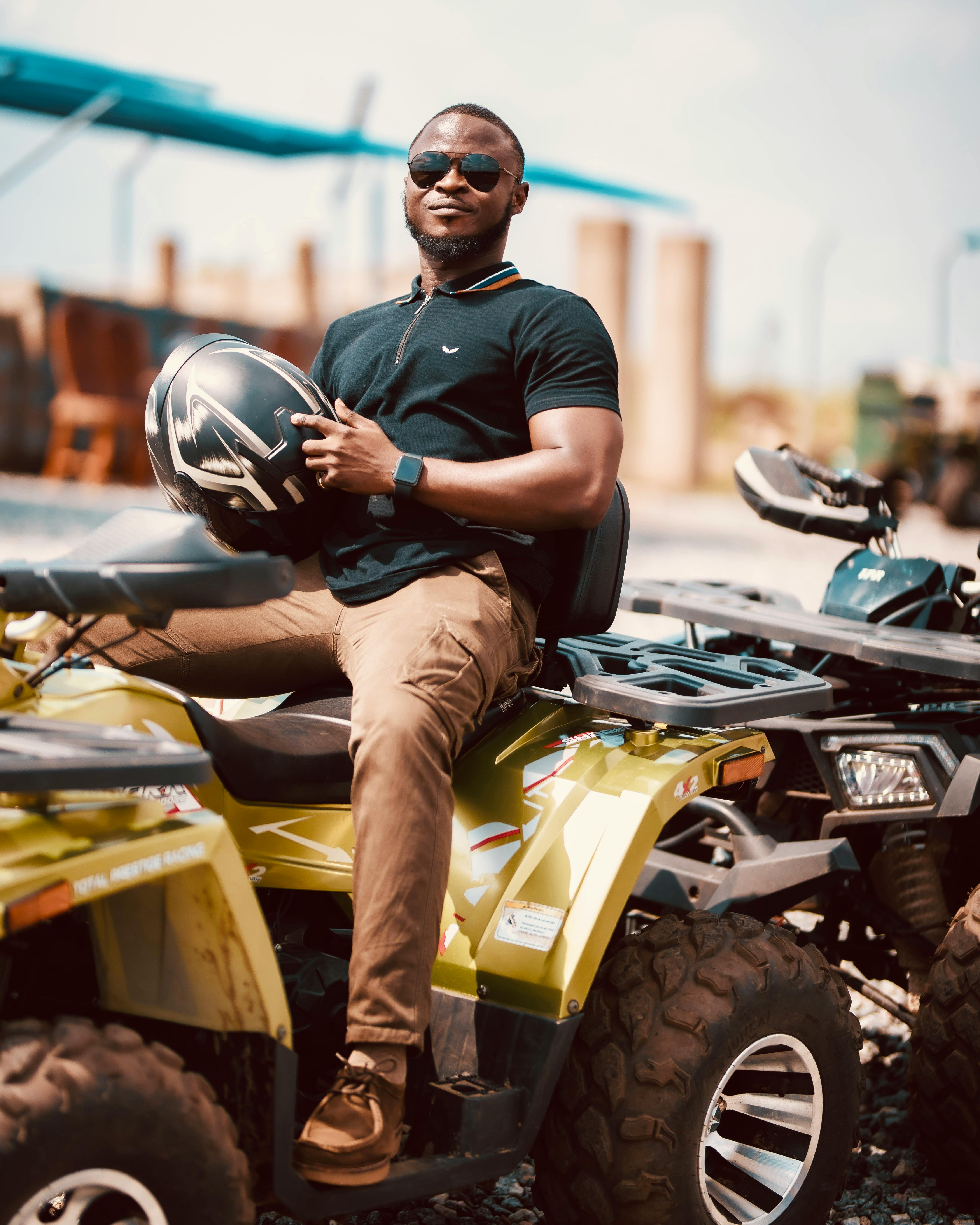 Man Sitting on a Quad Bike · Free Stock Photo