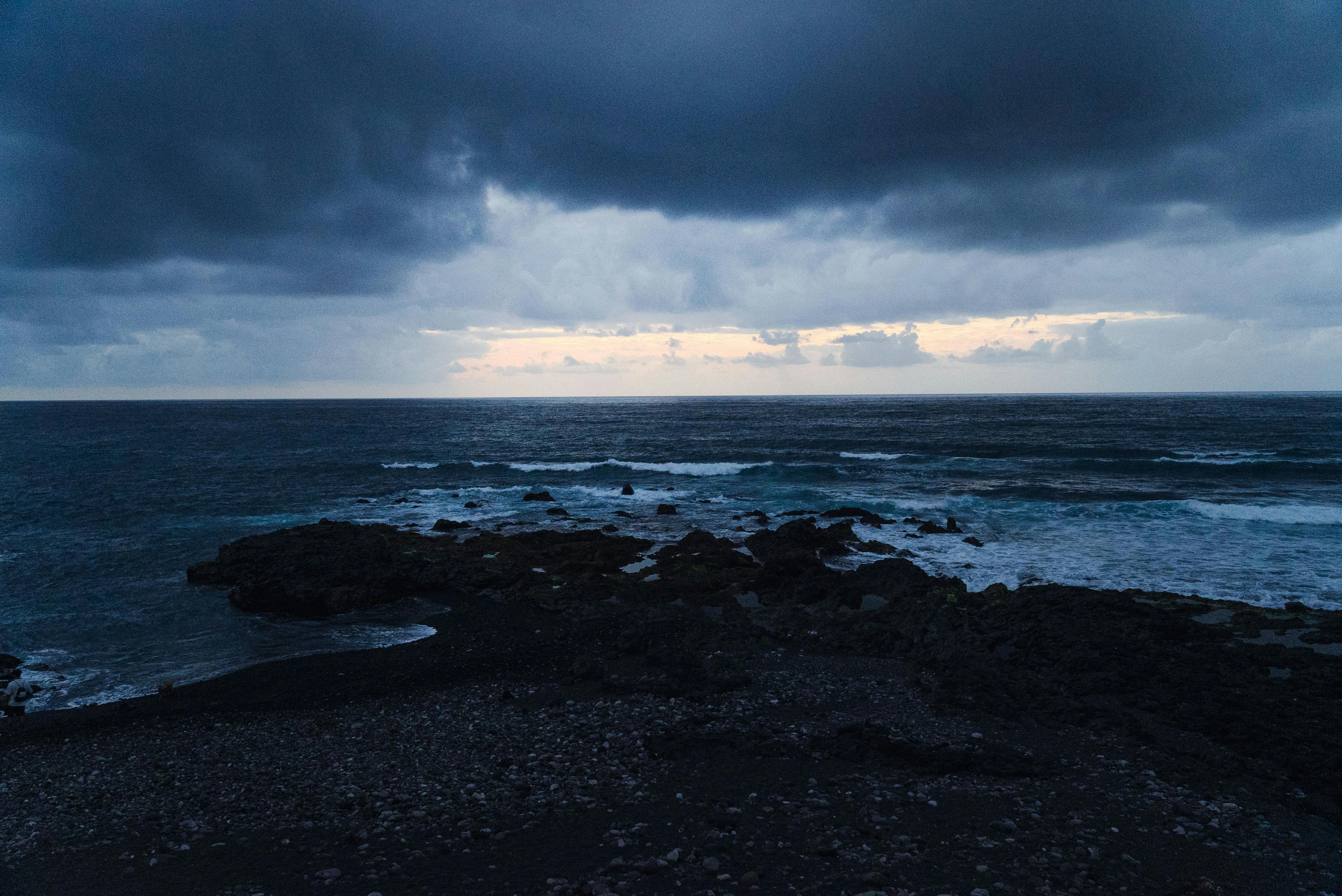 Rain Clouds over Sea Shore at Sunset · Free Stock Photo