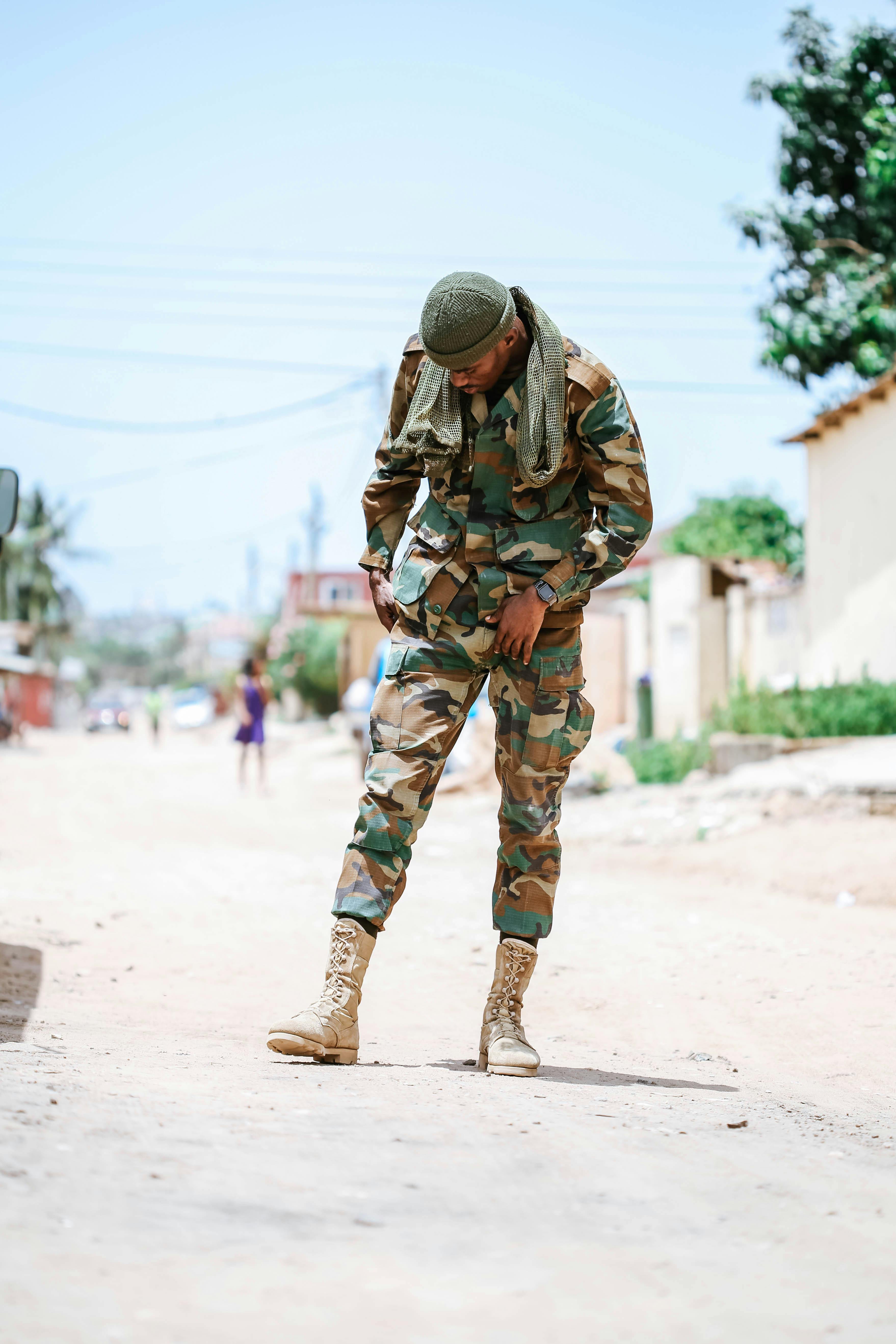 Man in Military Uniform Walking in Village · Free Stock Photo