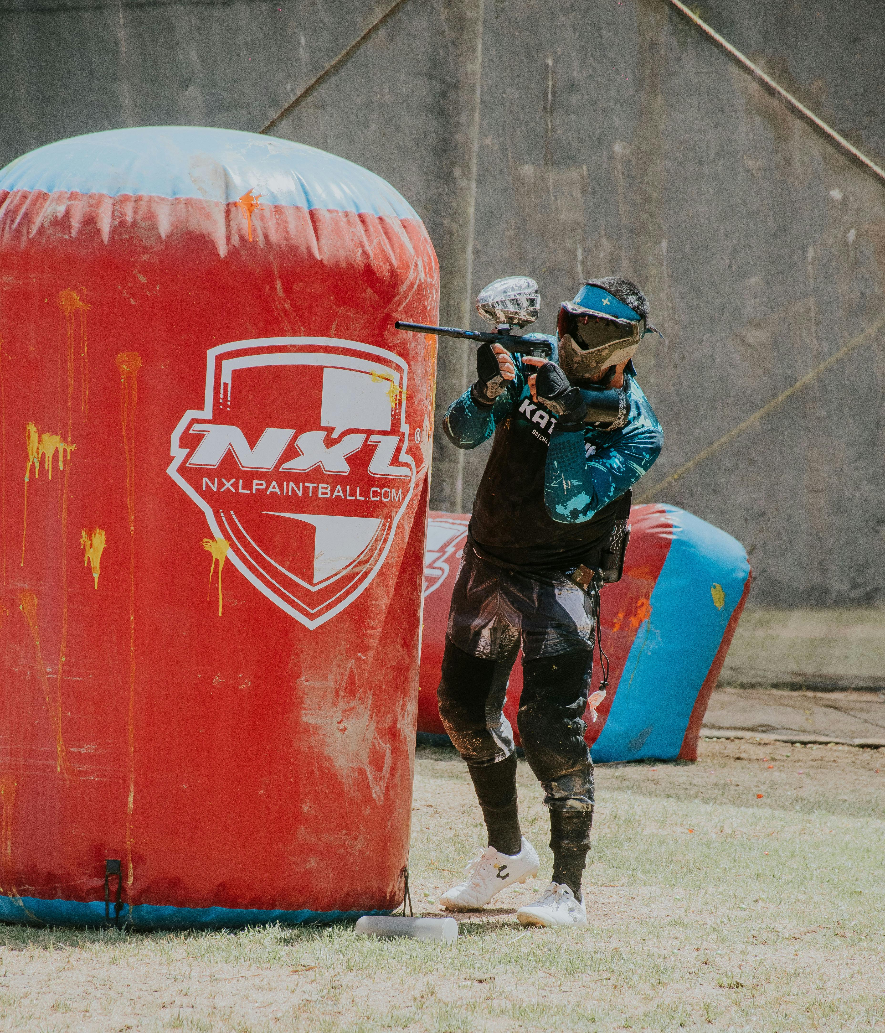Person Aiming with Paintball Rifle · Free Stock Photo