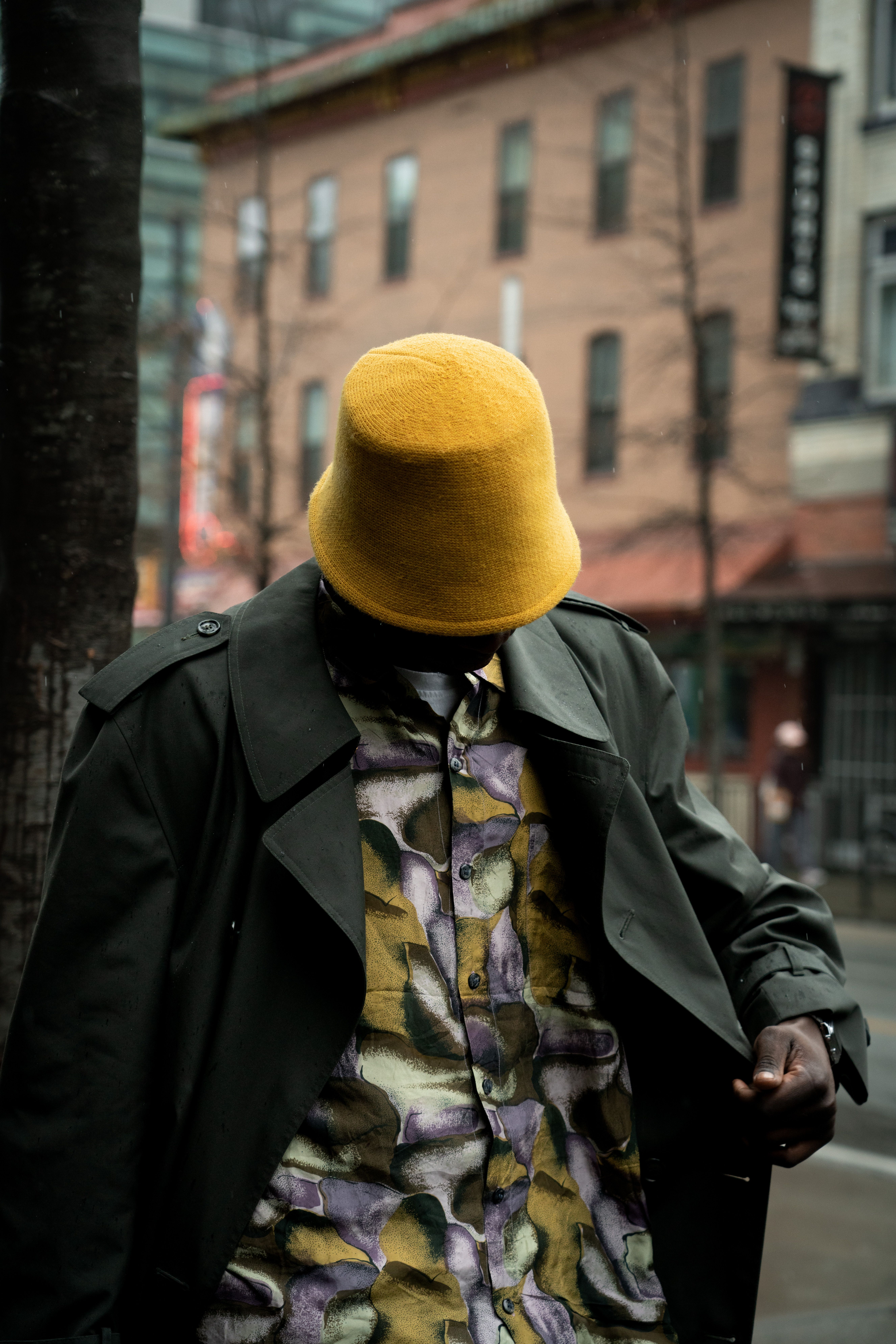 Man in Yellow Woolen Bucket Hat Walking on Street · Free Stock Photo