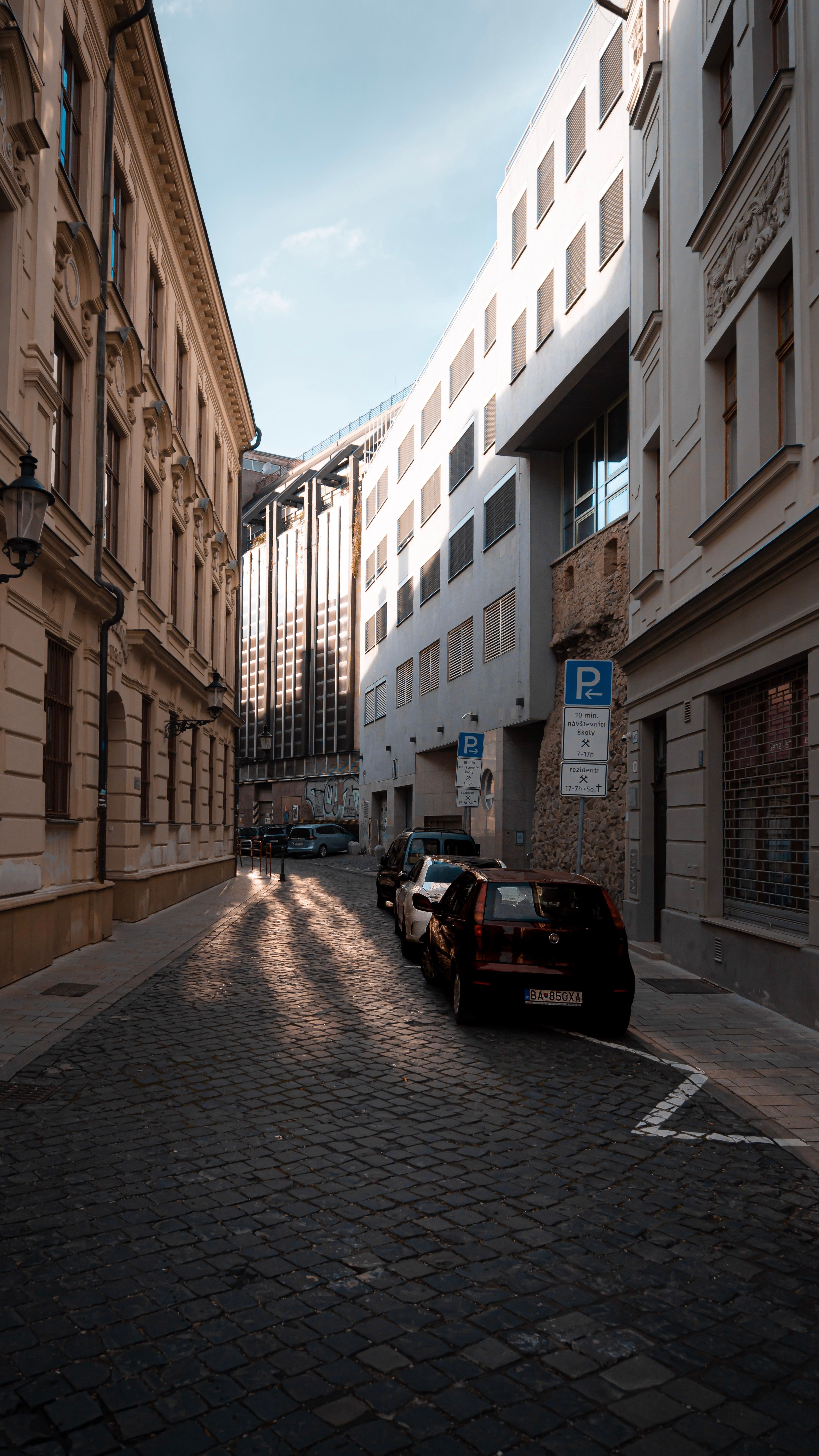 Parked Cars between the Concrete Buildings · Free Stock Photo