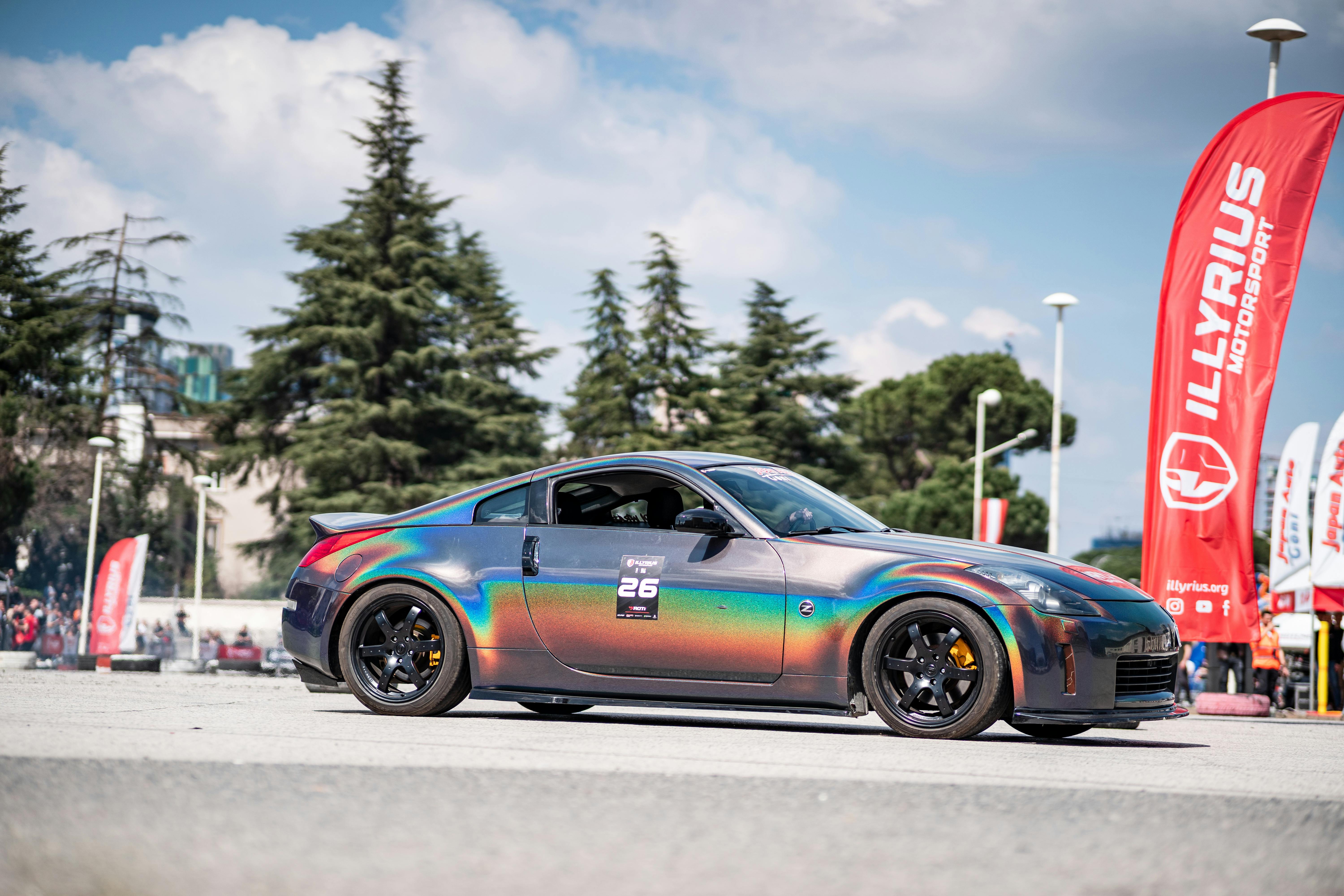 A Car with a Holographic Car Wrap at a Car Show · Free Stock Photo