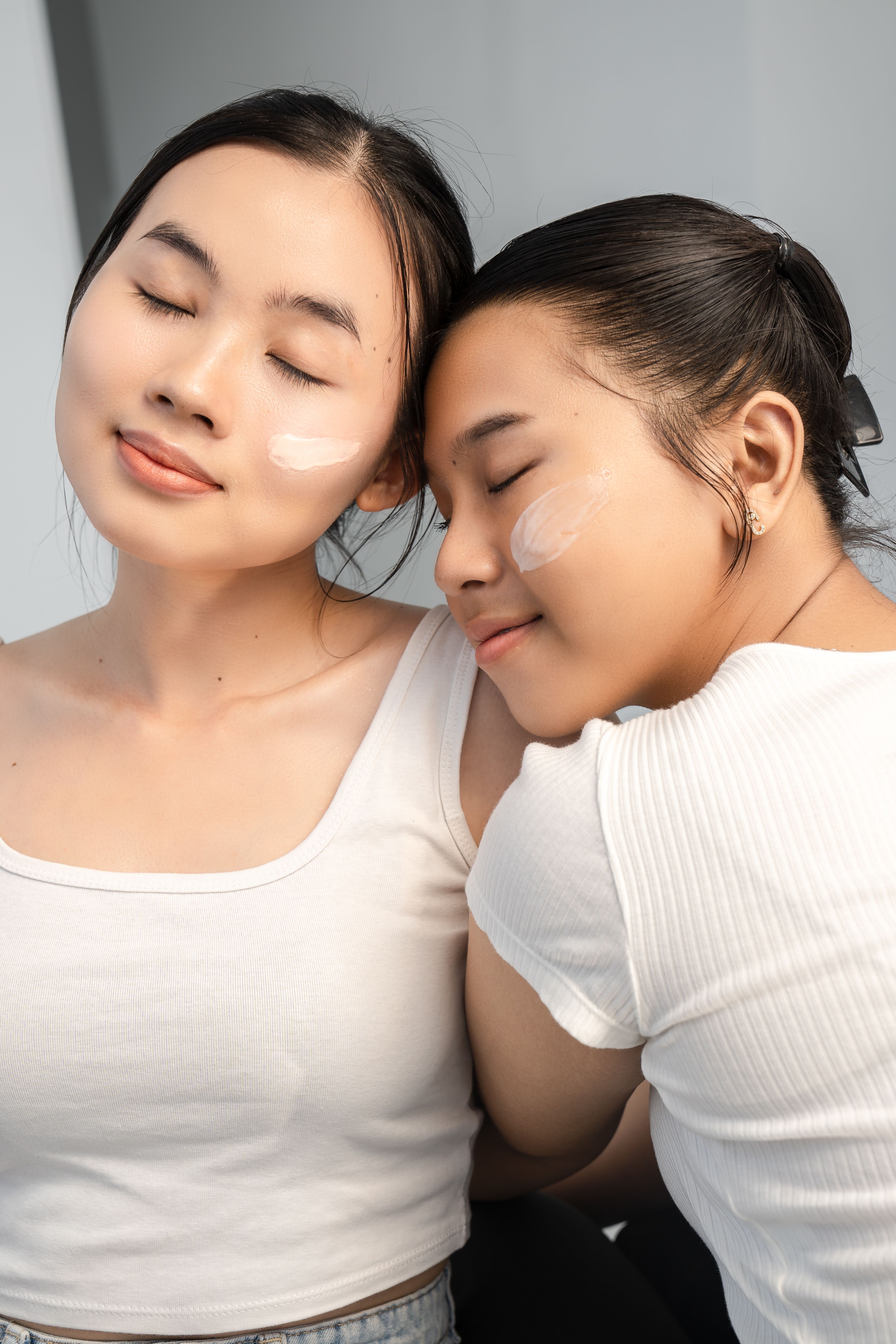 Two Smiling Girls with their Eyes Closed · Free Stock Photo