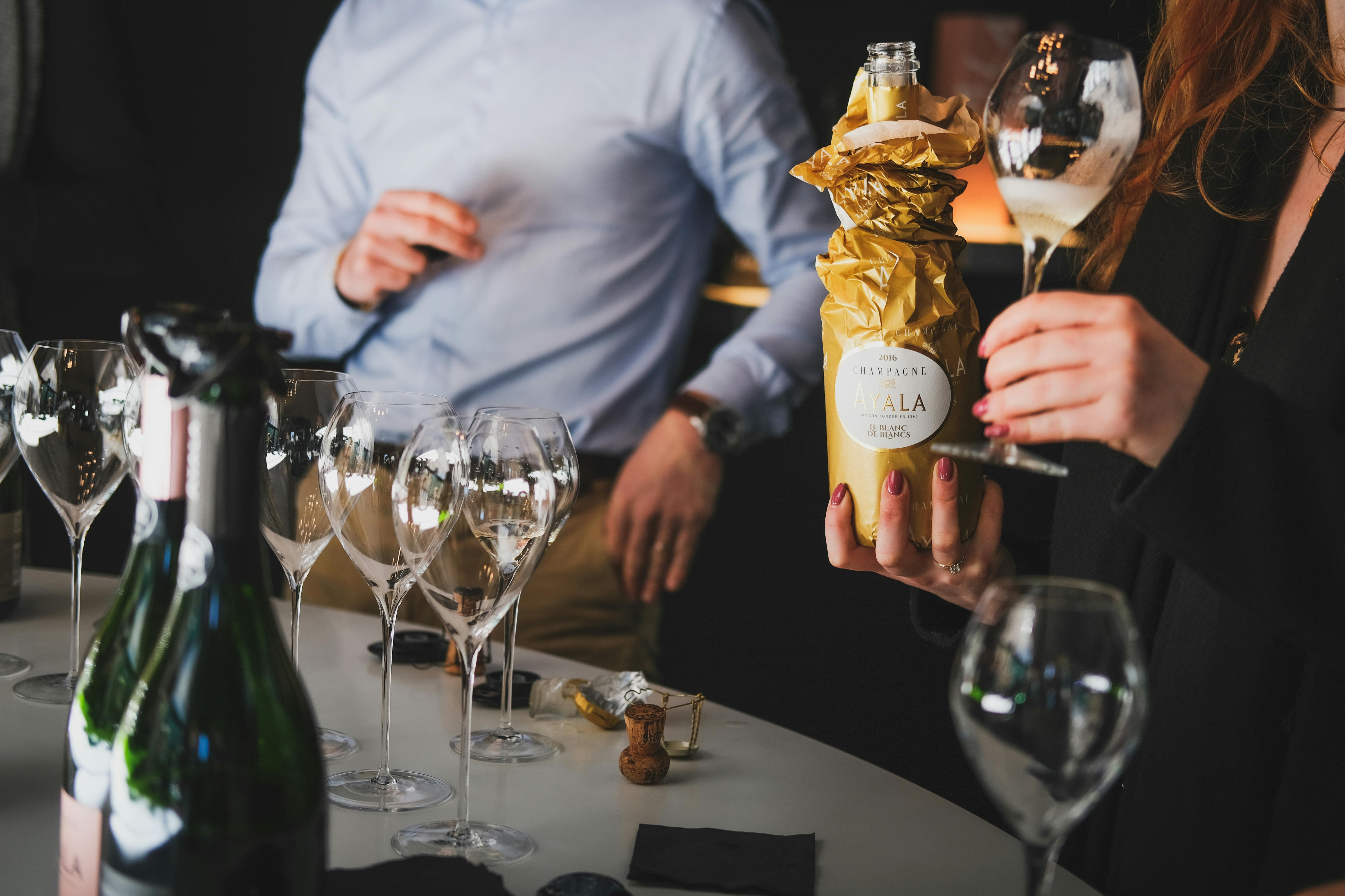 Woman Pouring Champagne in a Bed · Free Stock Photo
