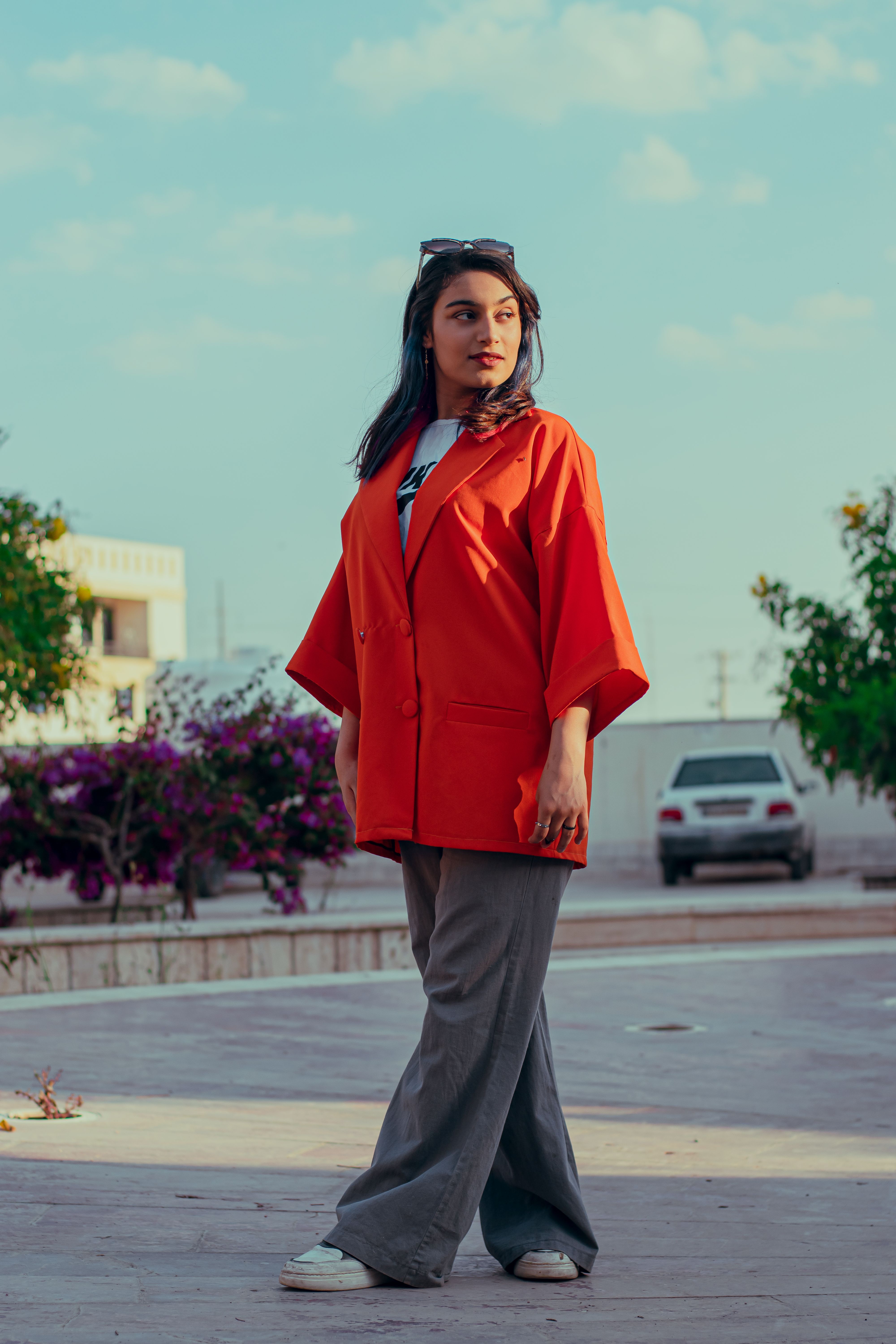 A Young Woman Wearing Orange Jacket Walking on the Street · Free Stock ...